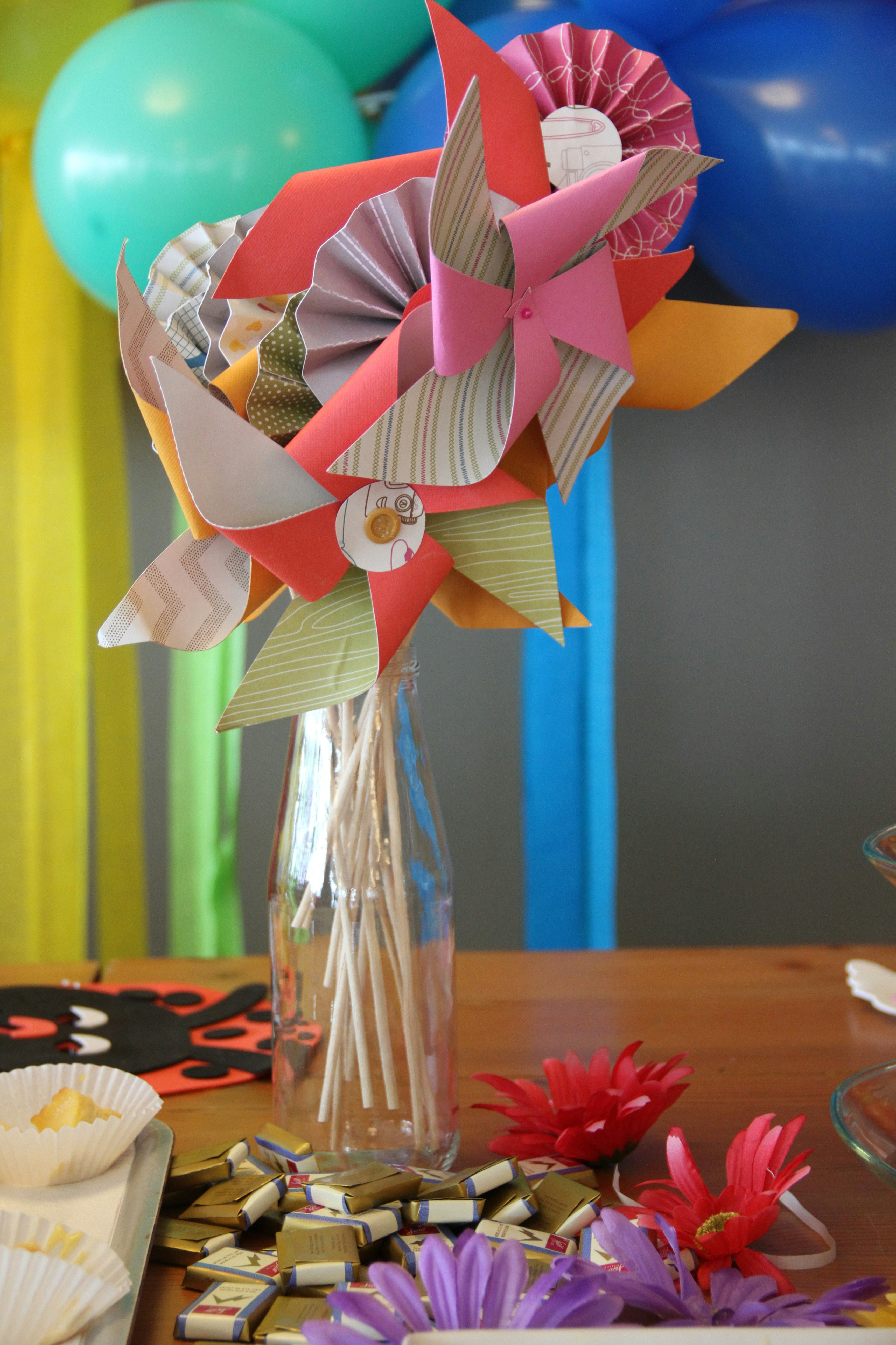 Colorful pinwheels in a vase with candy and balloons. photo – Free ...
