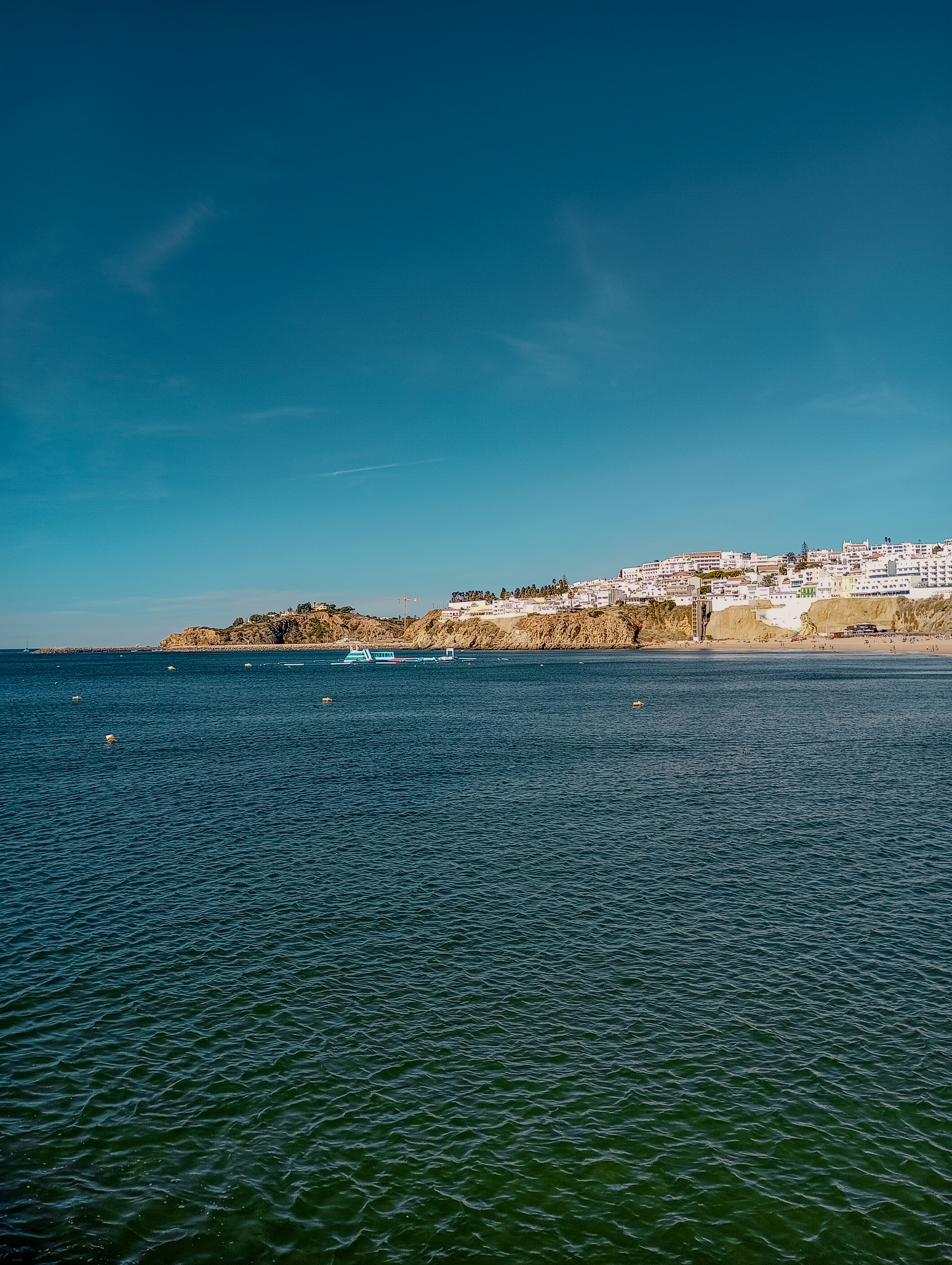 Coastal town with white buildings overlooking the ocean.