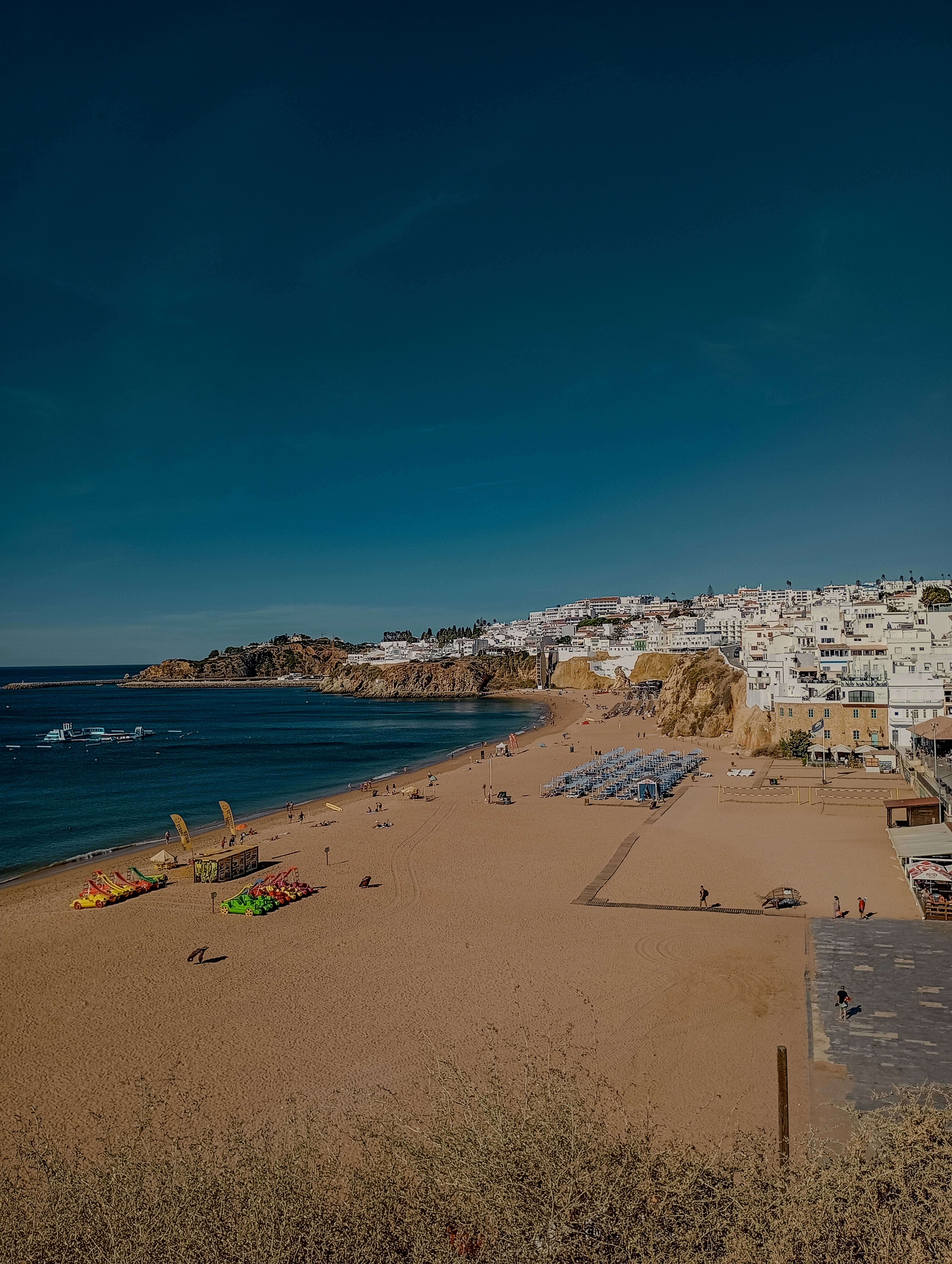 Sandy beach with white buildings overlooking ocean
