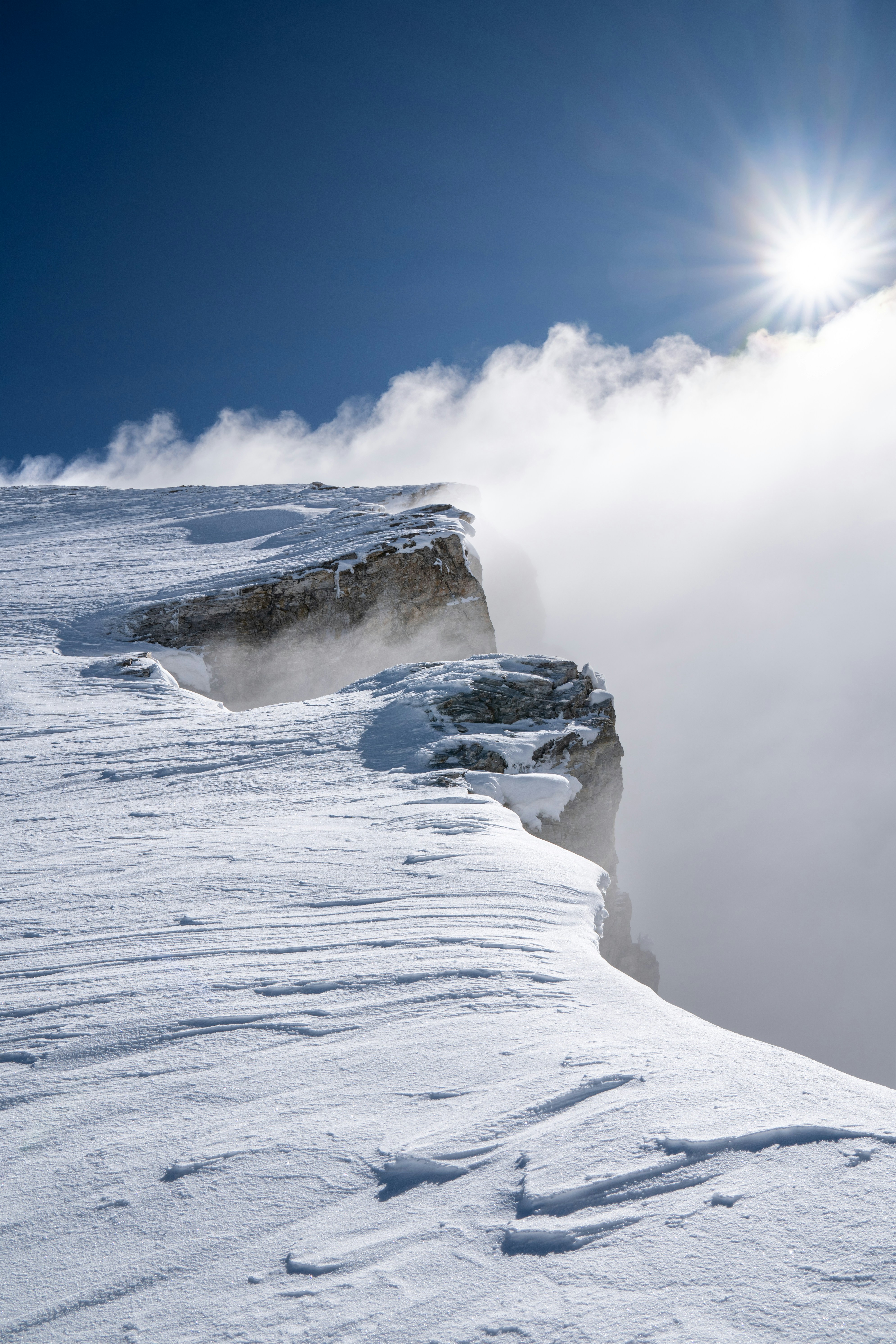 Snowy cliff edge with sun and mist photo – Free Switzerland Image on ...