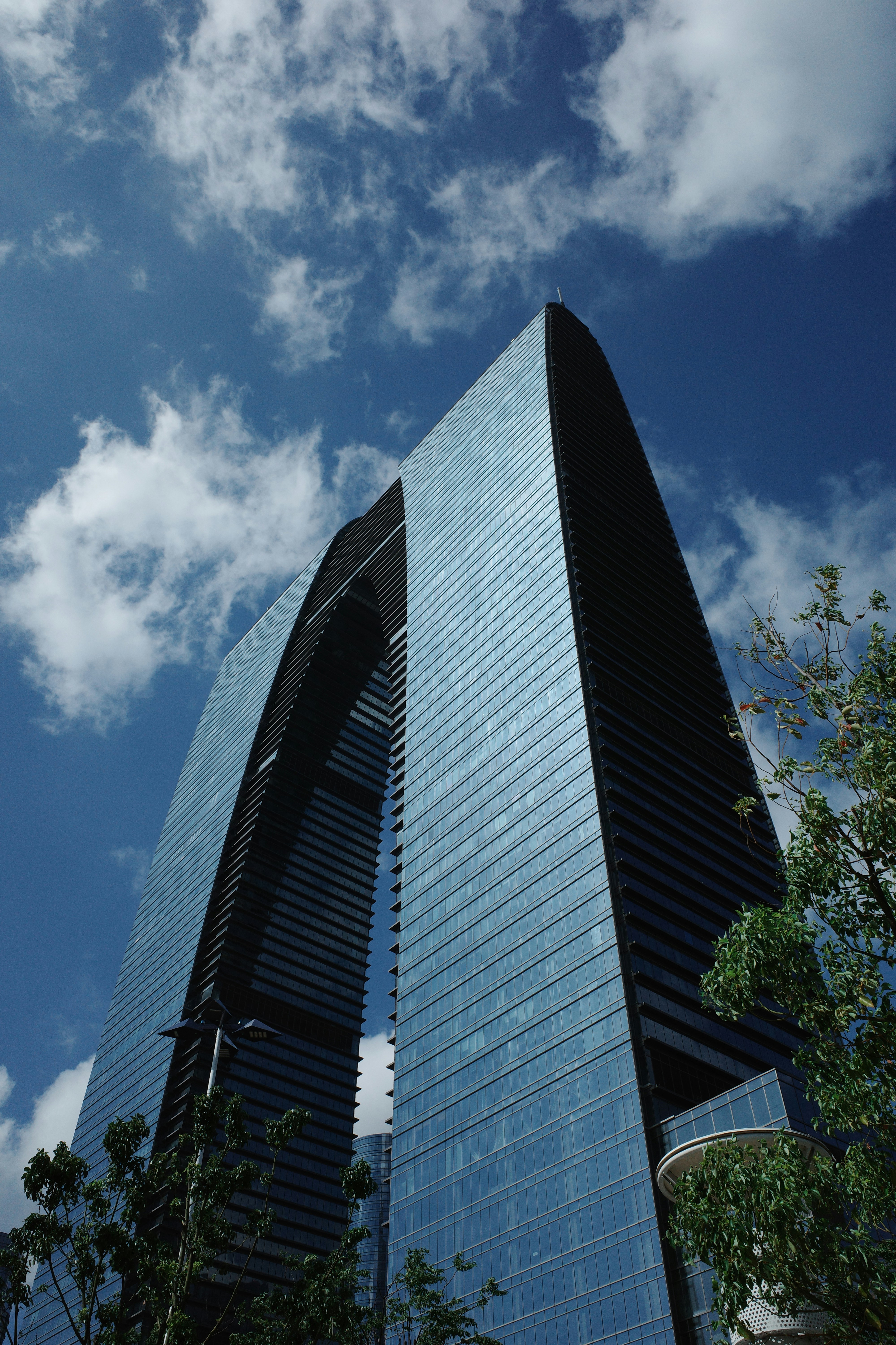 Gate of the Orient | 东方之门 (Dōngfāng zhī mén) | Modern skyscraper with glass facade against blue sky