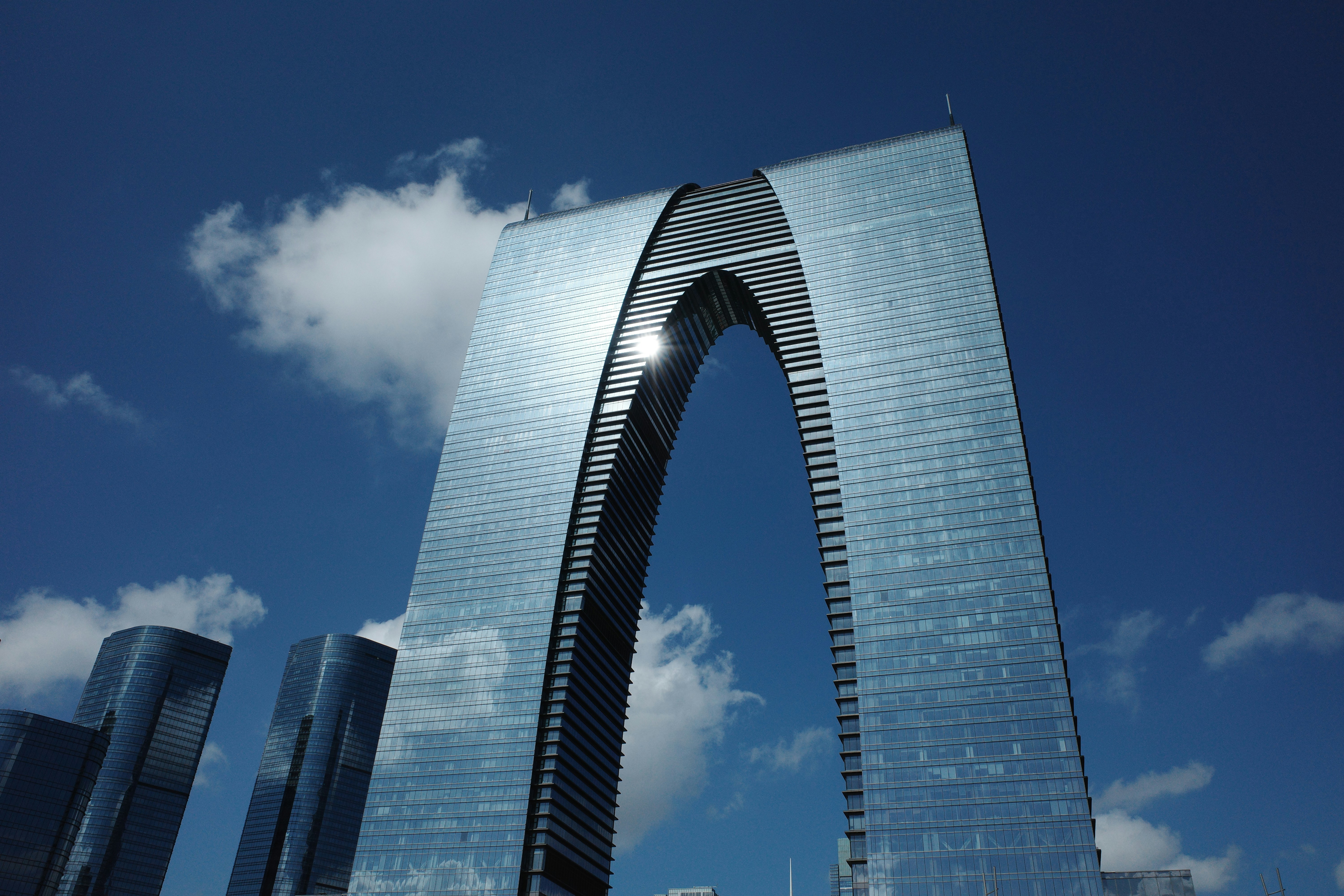 Gate of the Orient | 东方之门 (Dōngfāng zhī mén) | Modern arch skyscraper against a bright blue sky