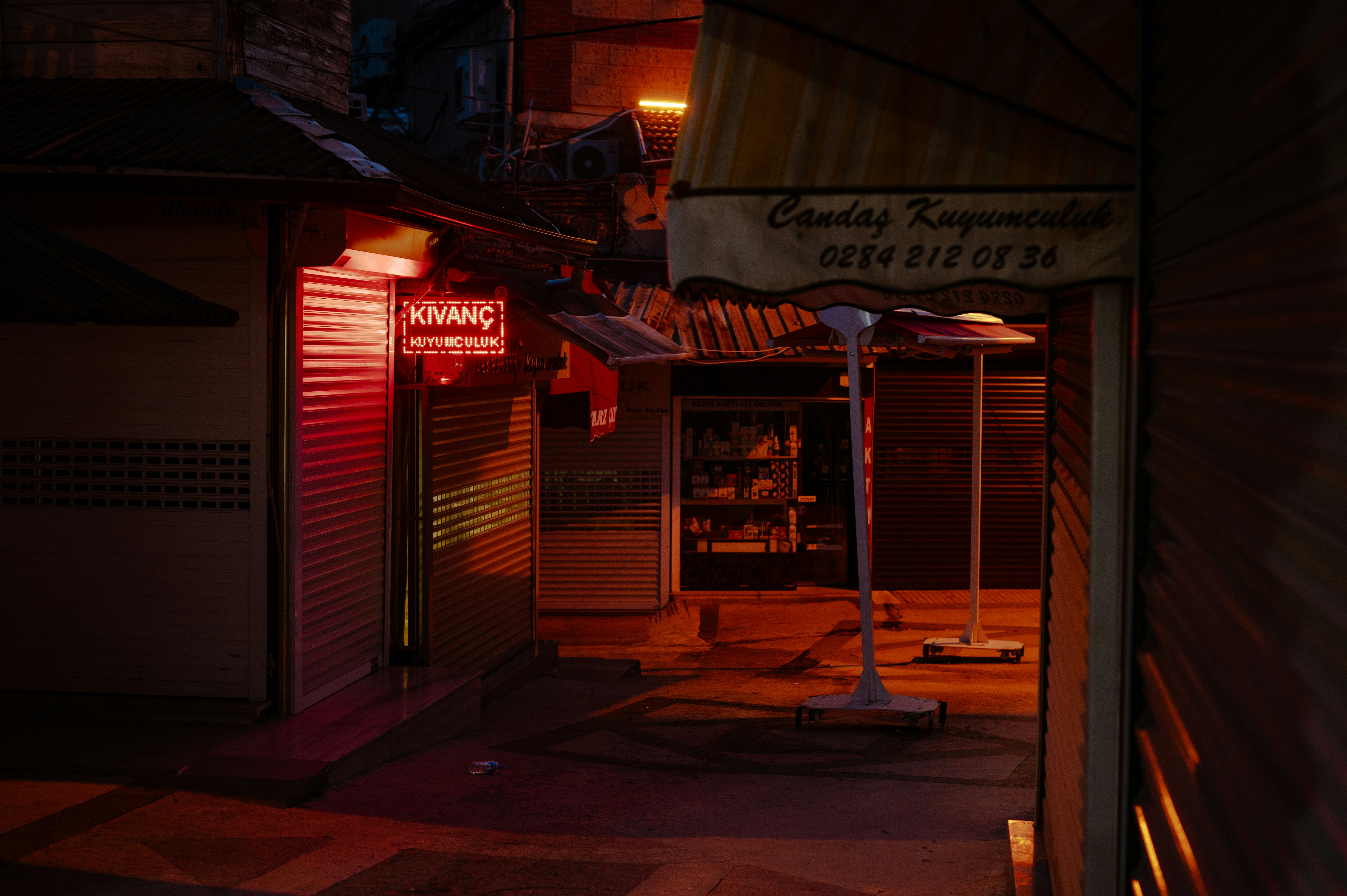 Dimly lit alleyway with glowing neon signs
