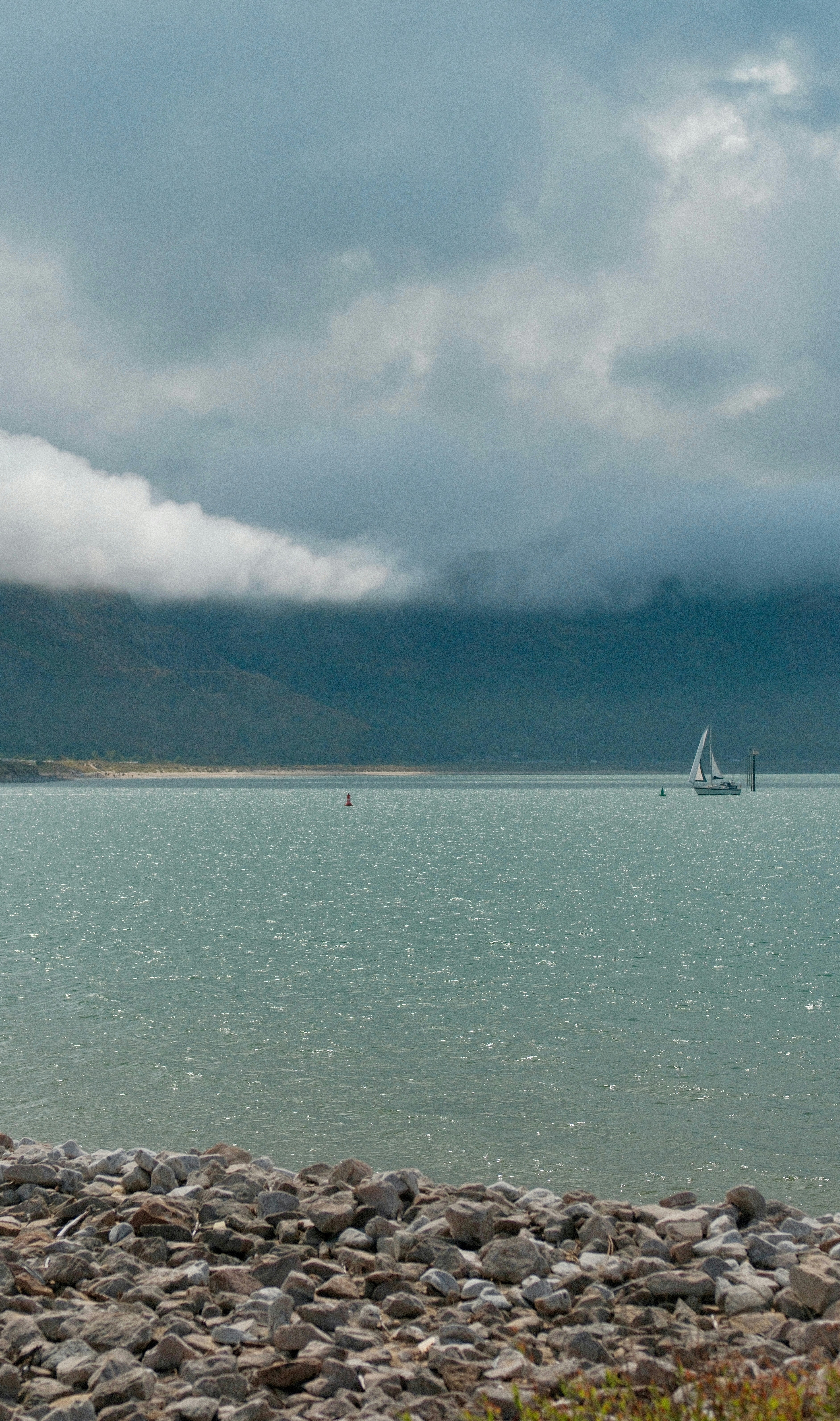 Sailing Through Tranquil Waters Under a Cloudy Sky