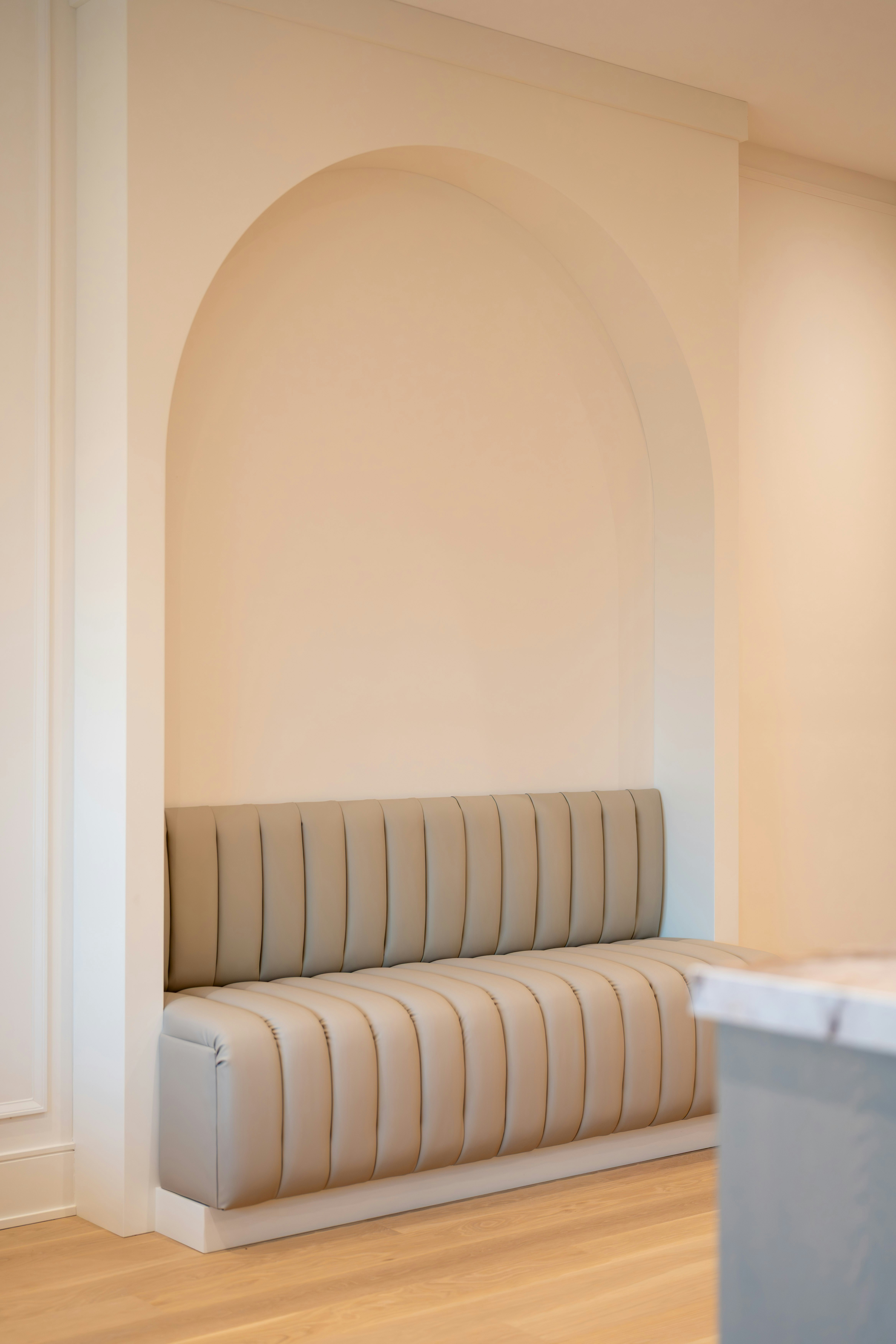 Built-in bench seating in an arched alcove.
