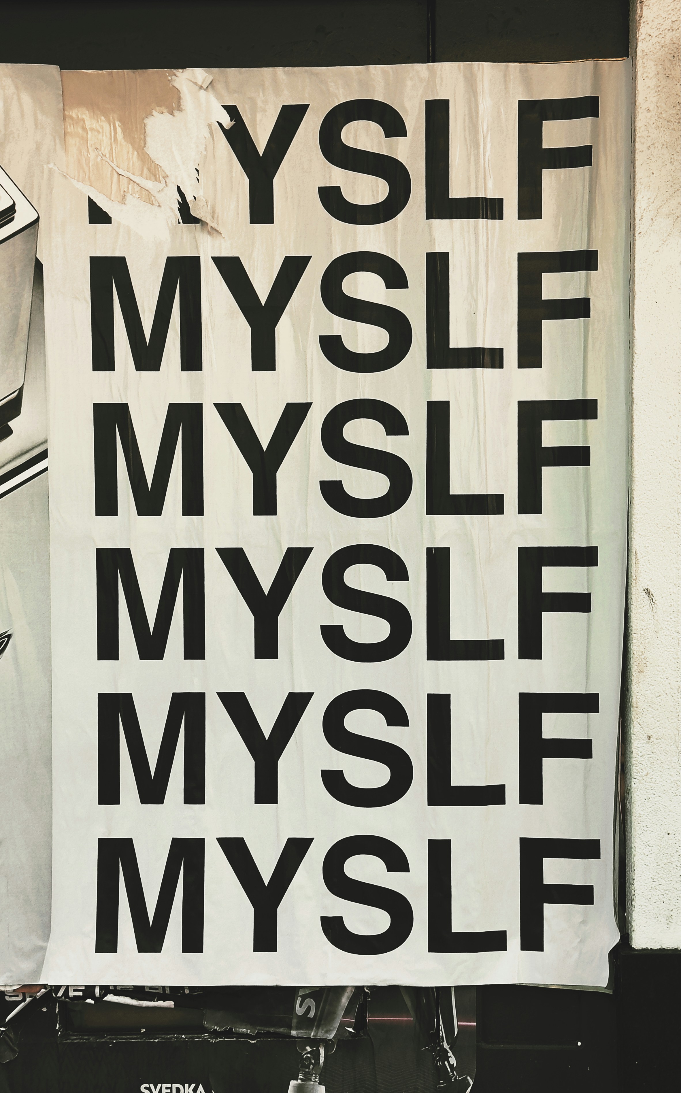 The word myself repeated on a poster.