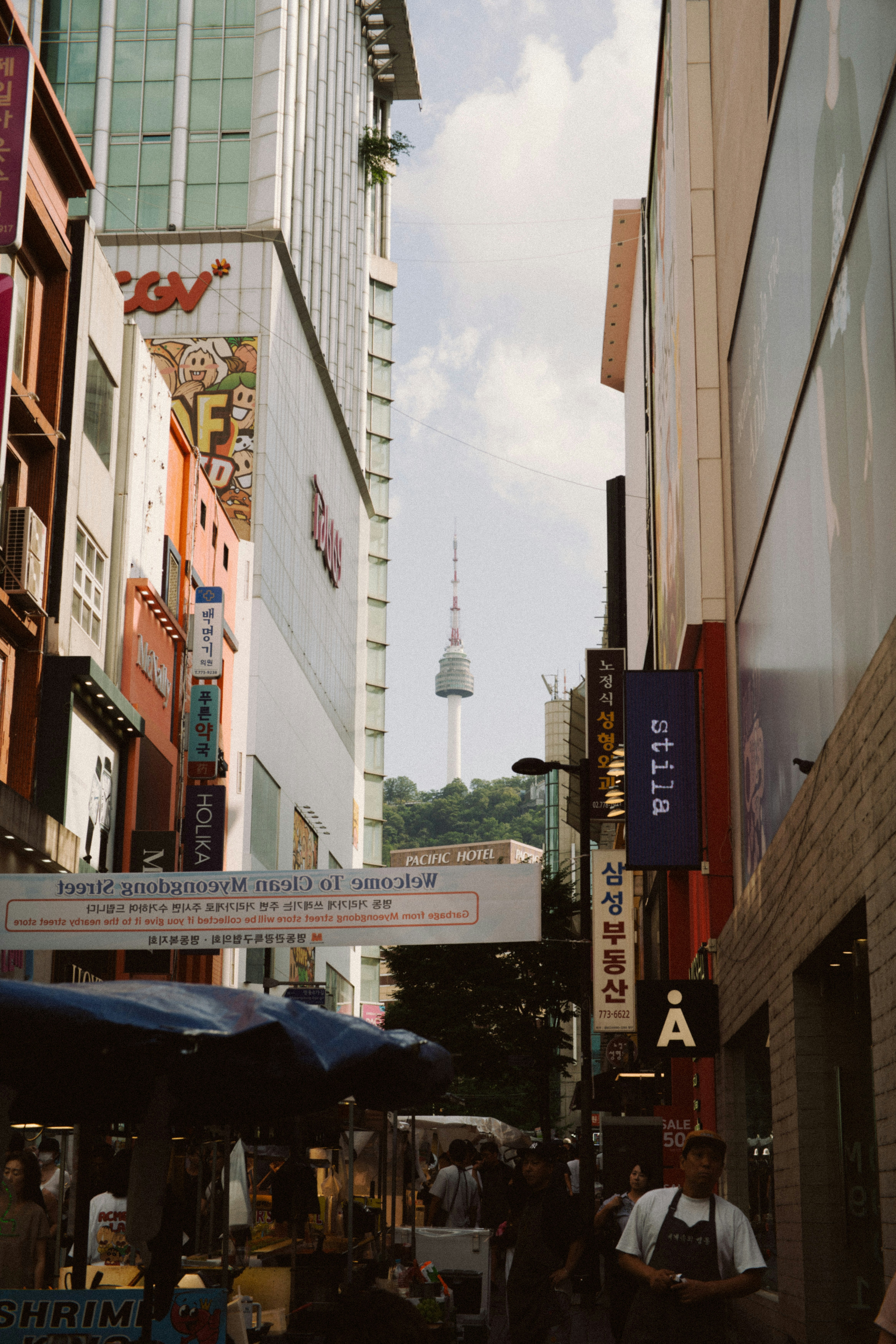 City street with namsan tower in the distance.