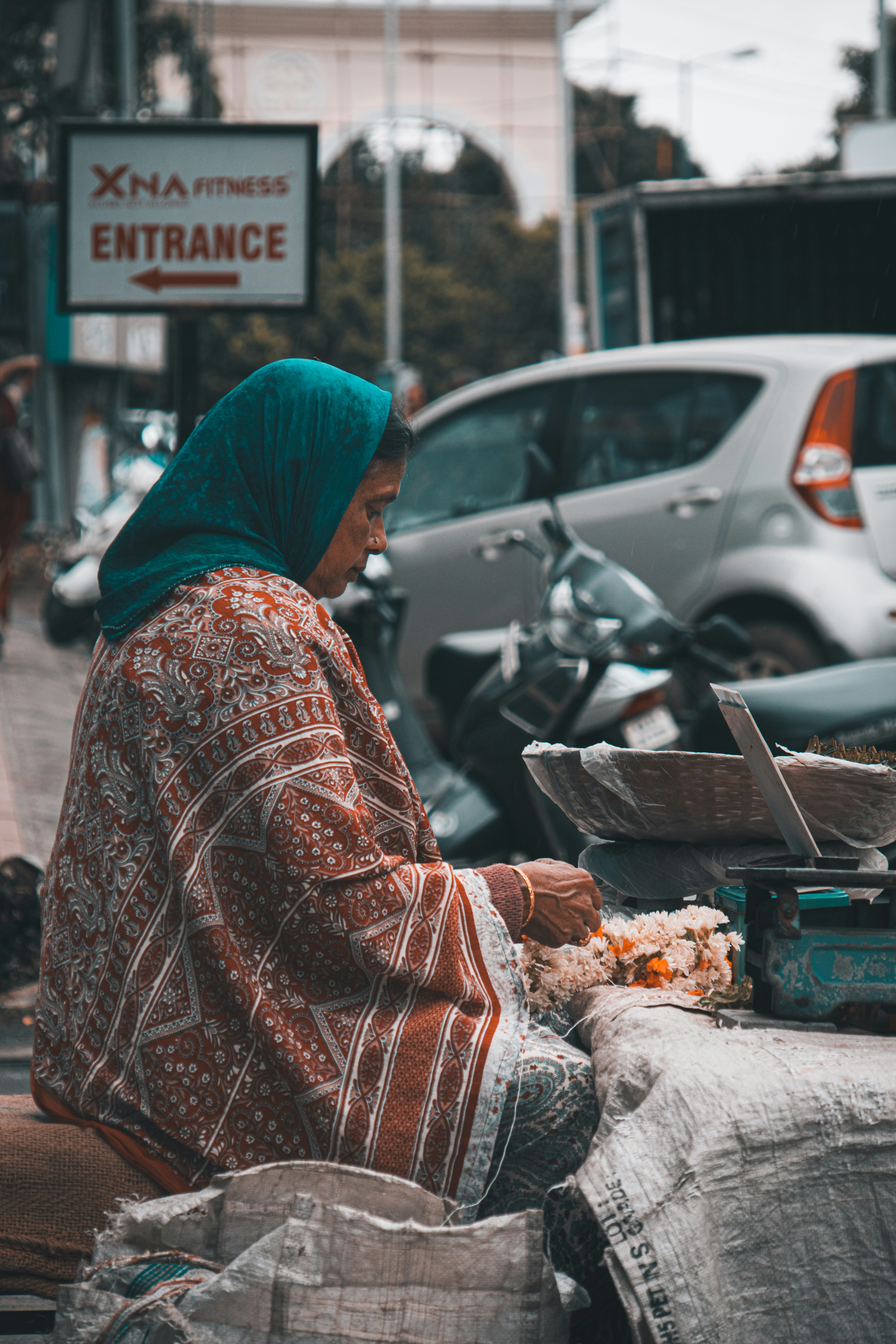 Woman selling flowers at a street market.
