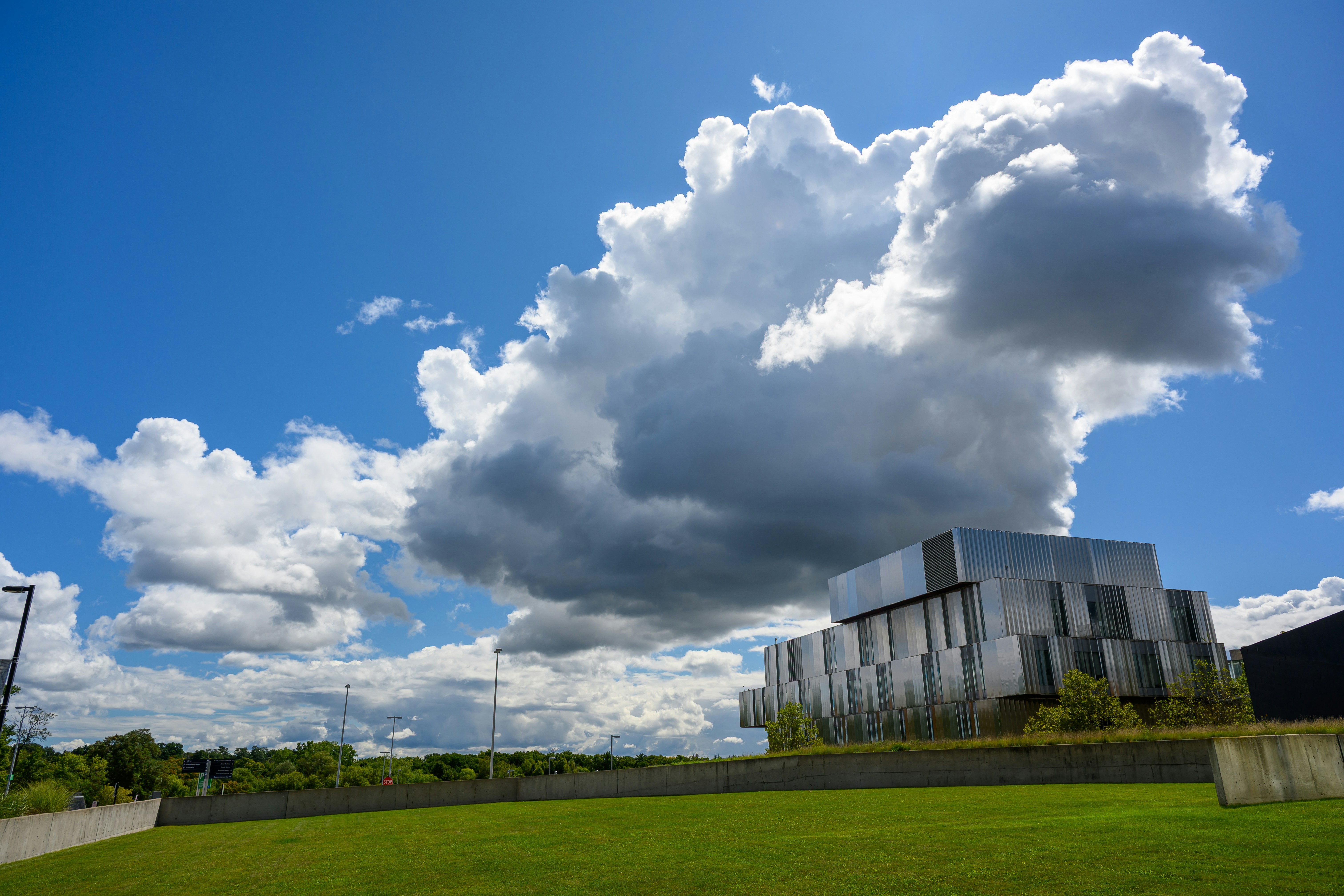 Clouds Over the Modern Block: Light, Shadow, and Green at the Park Edge