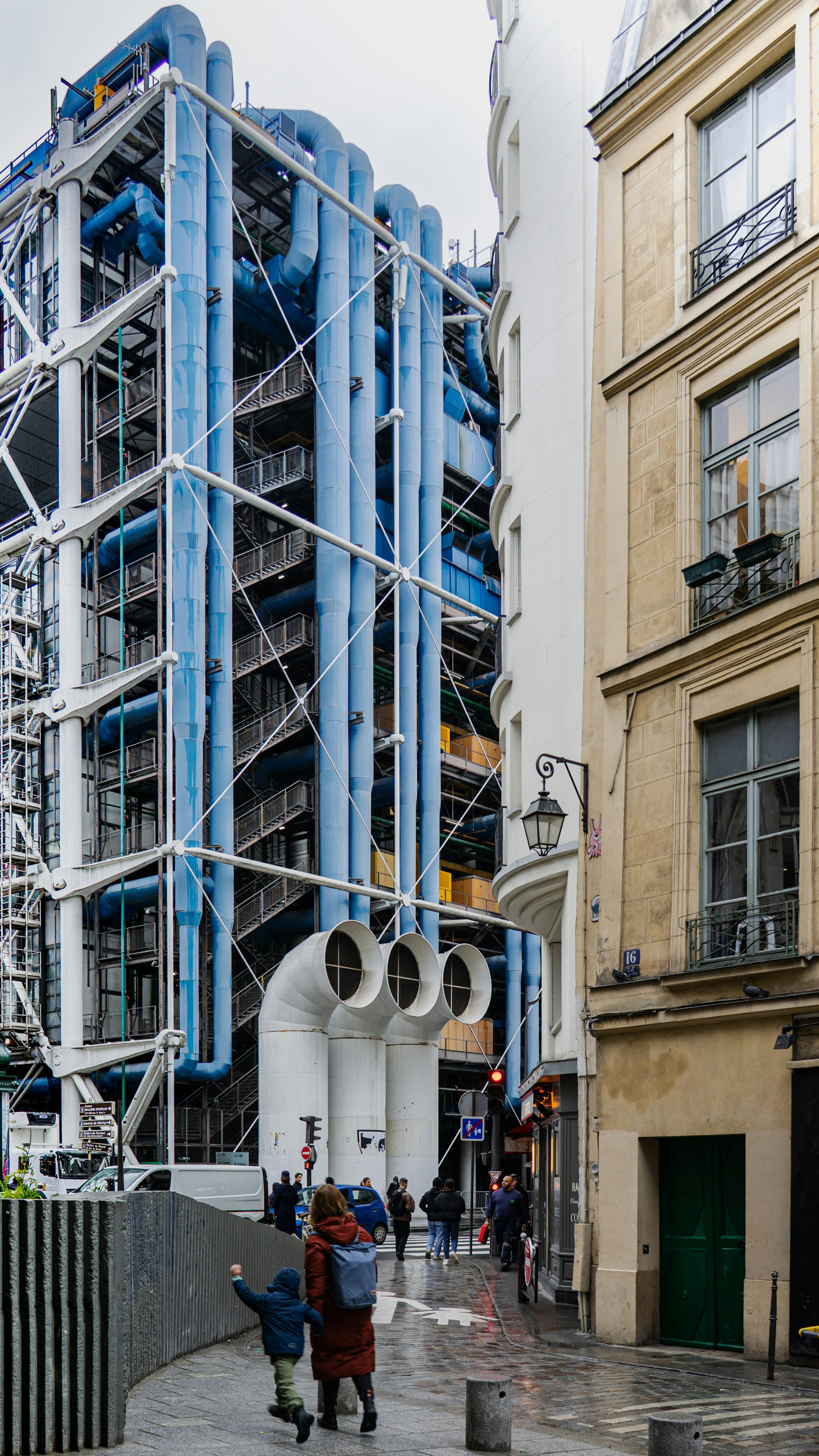 Modern building with blue pipes and street scene