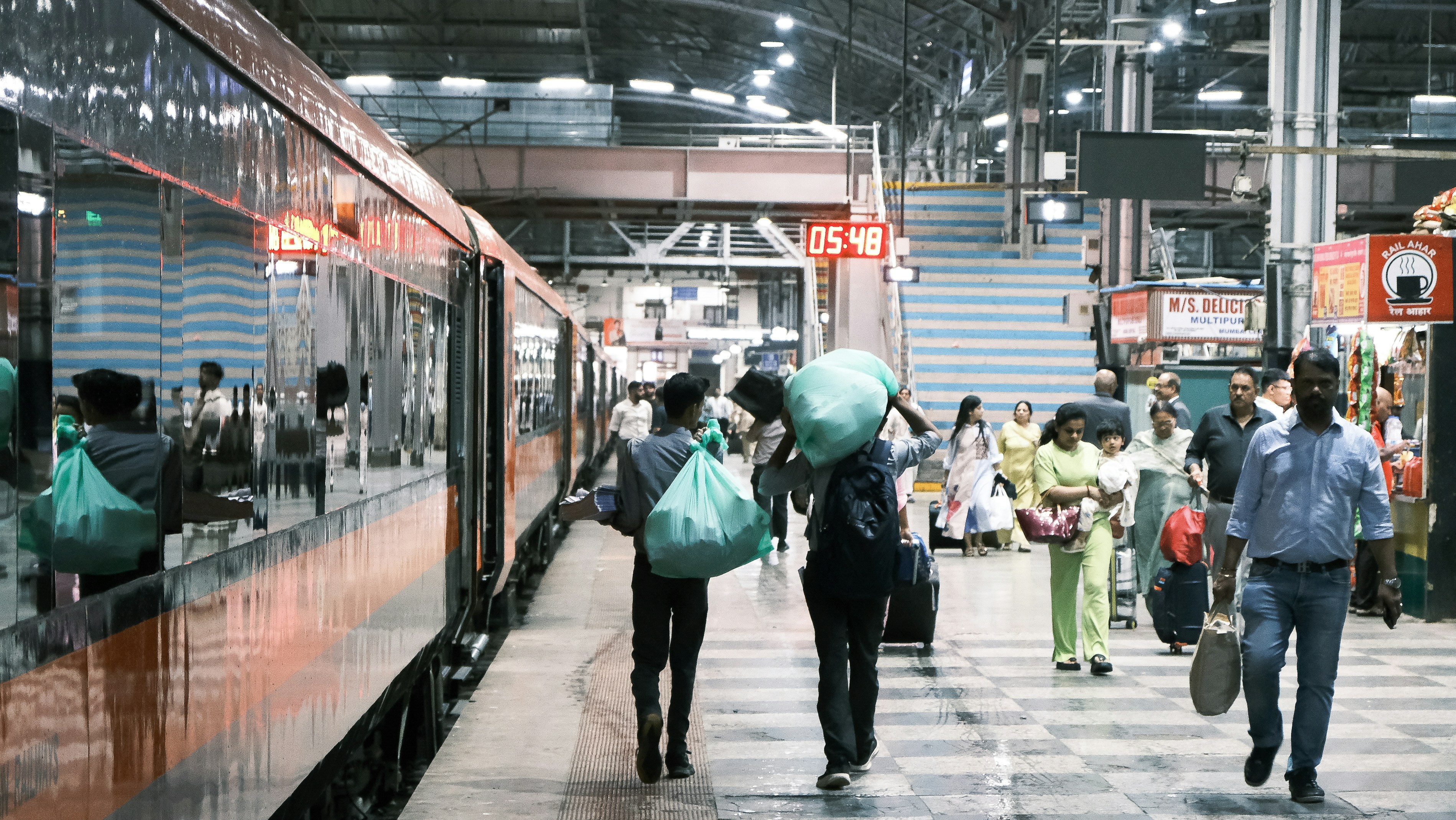 an early morning at Bombay Central. | People walking on a busy train station platform.