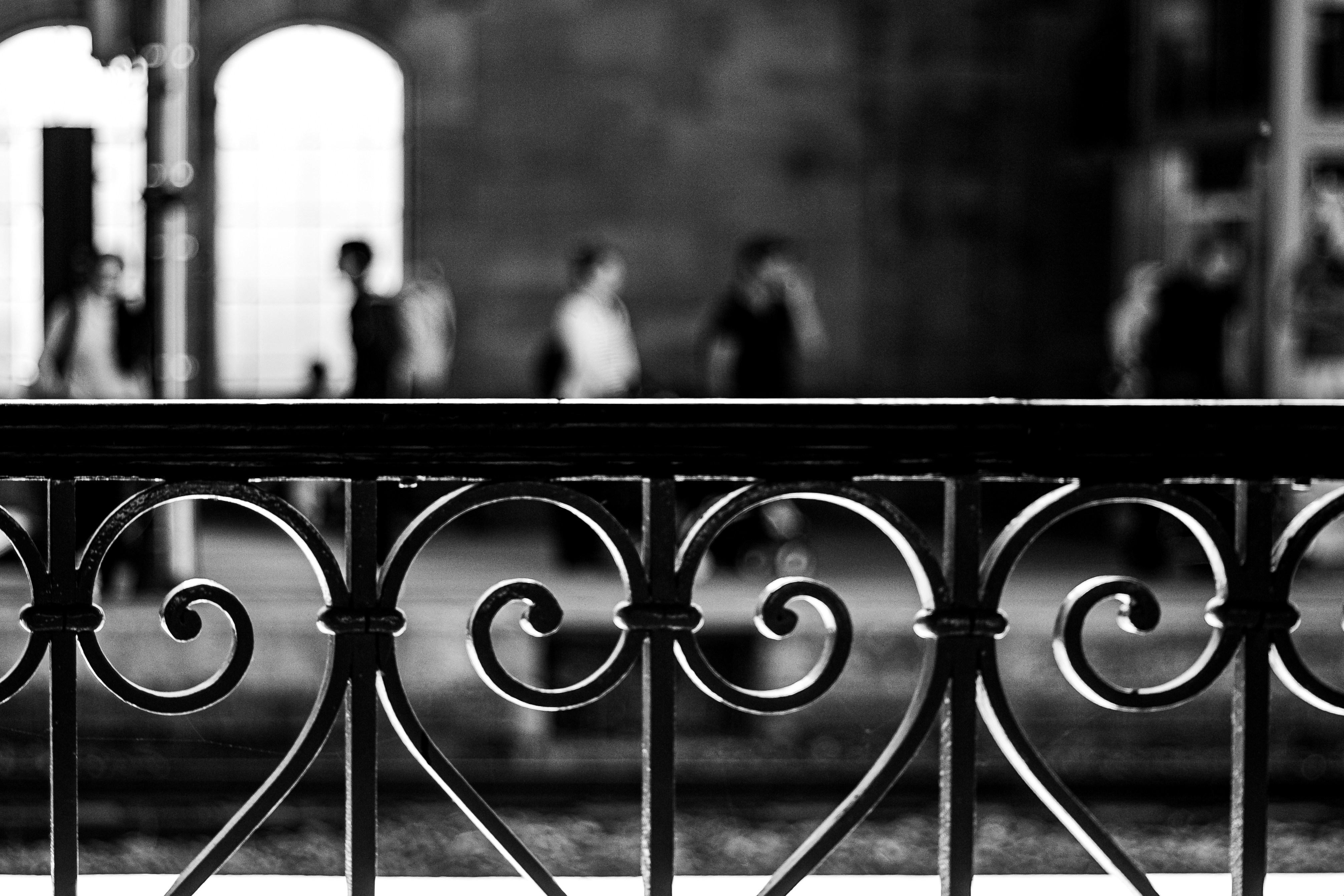 Strasbourg Station Interior in Black and White | Ornate railing with blurred figures in background