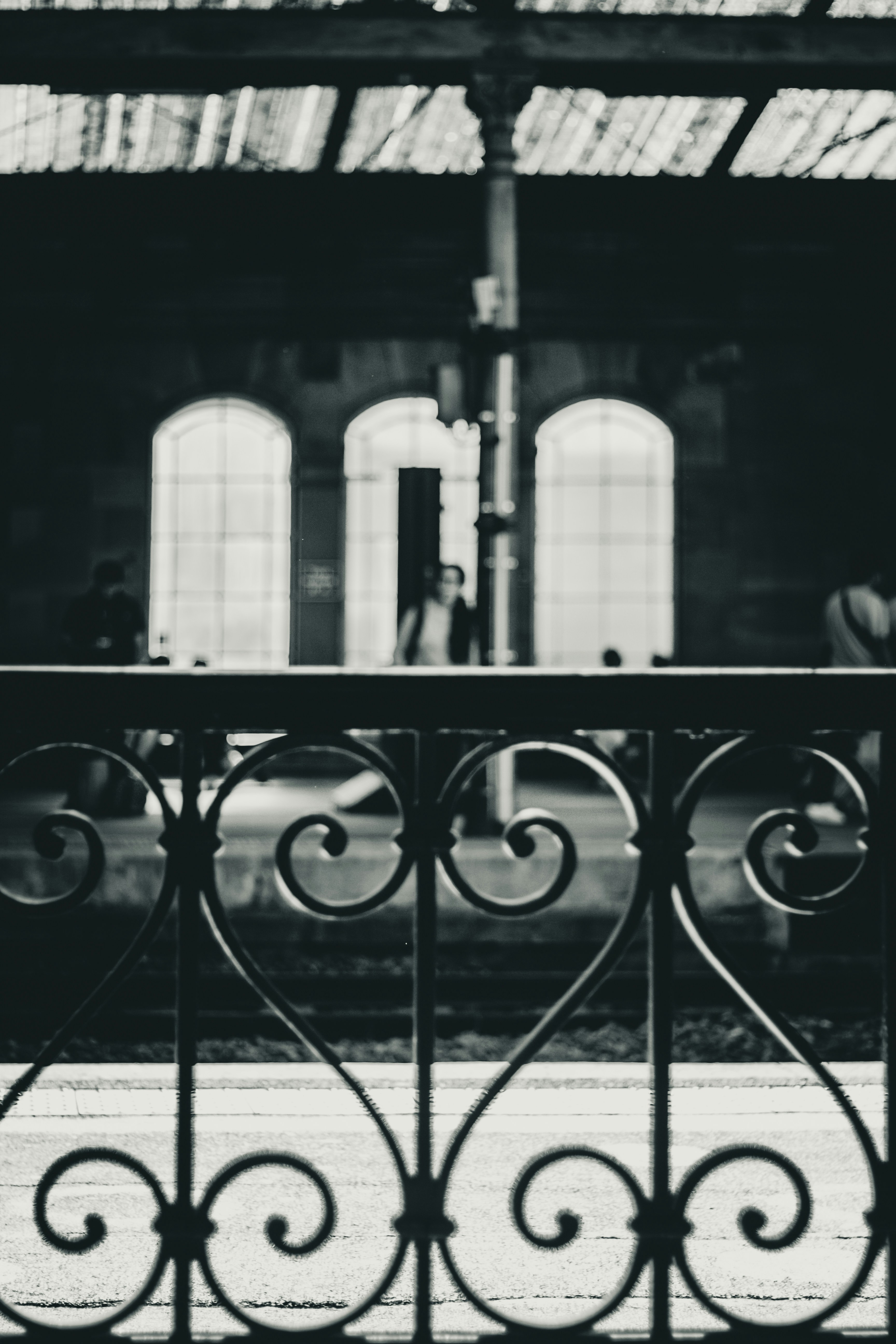 Iron Railing at Strasbourg Station | Ornate metal railing in front of arched windows