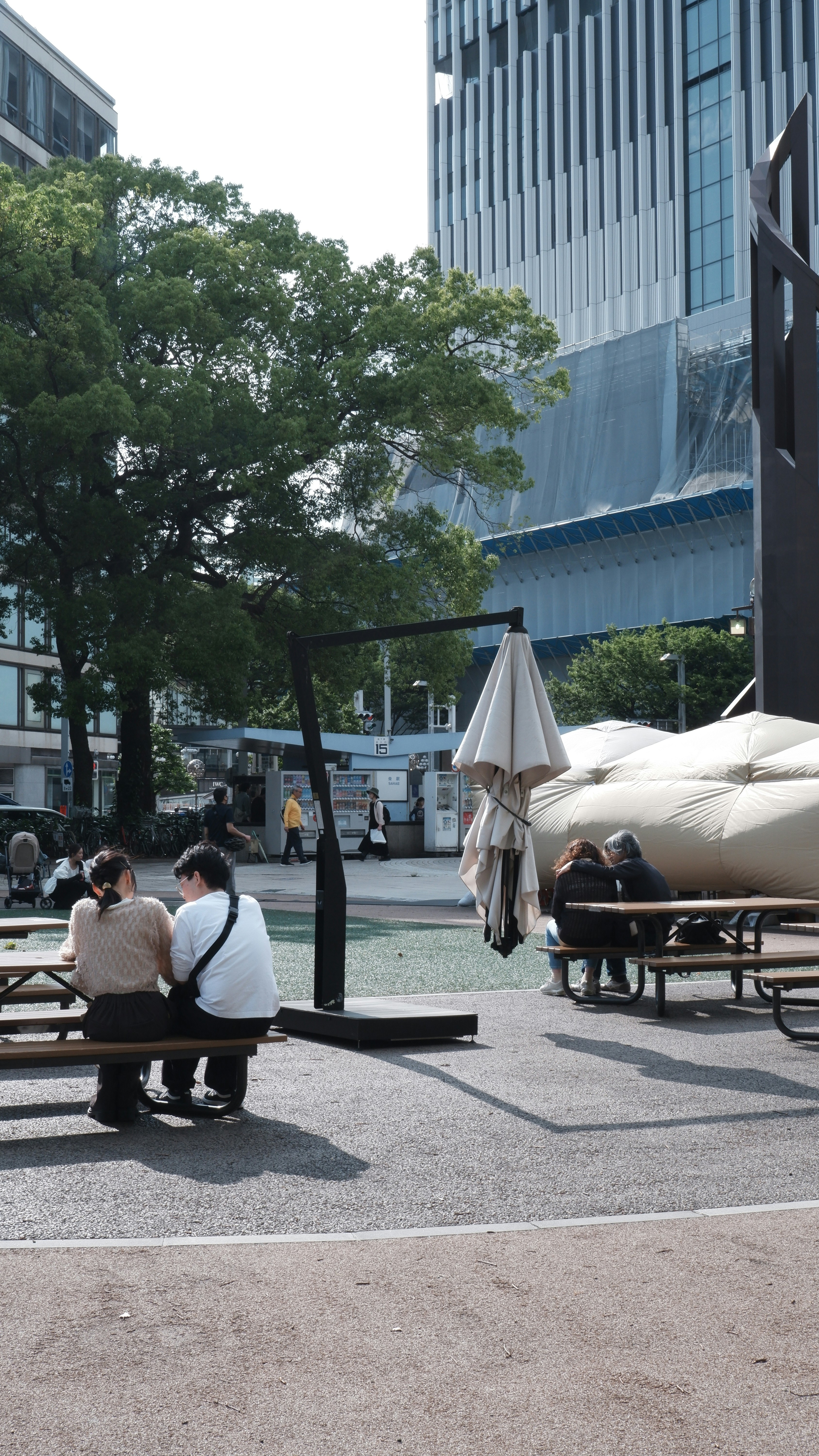 Urban Respite: Benchside Moments Under a Sculptural Canopy