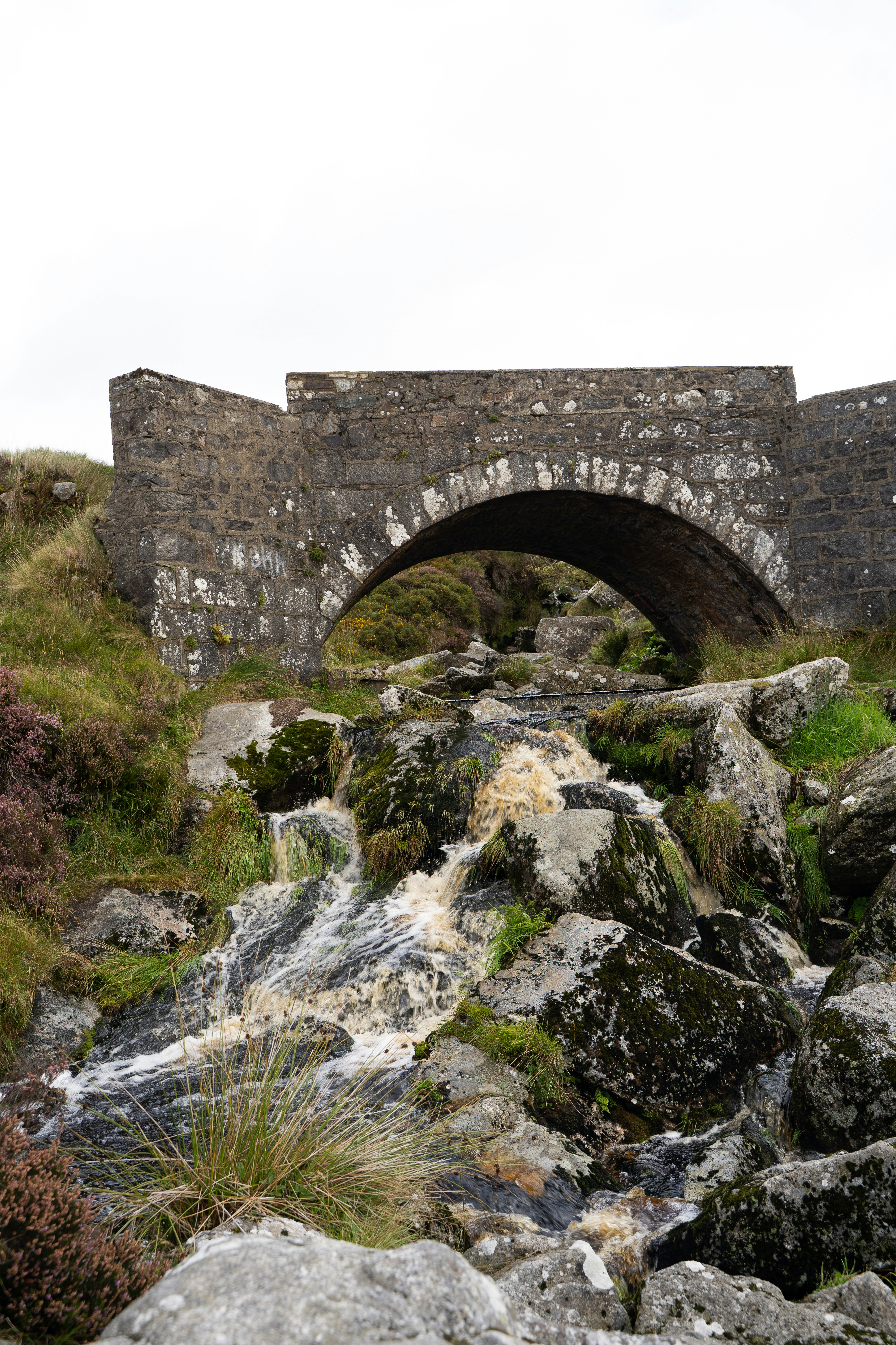 Stone Arch over a Mossy Cascade: Quiet Highland Crossing