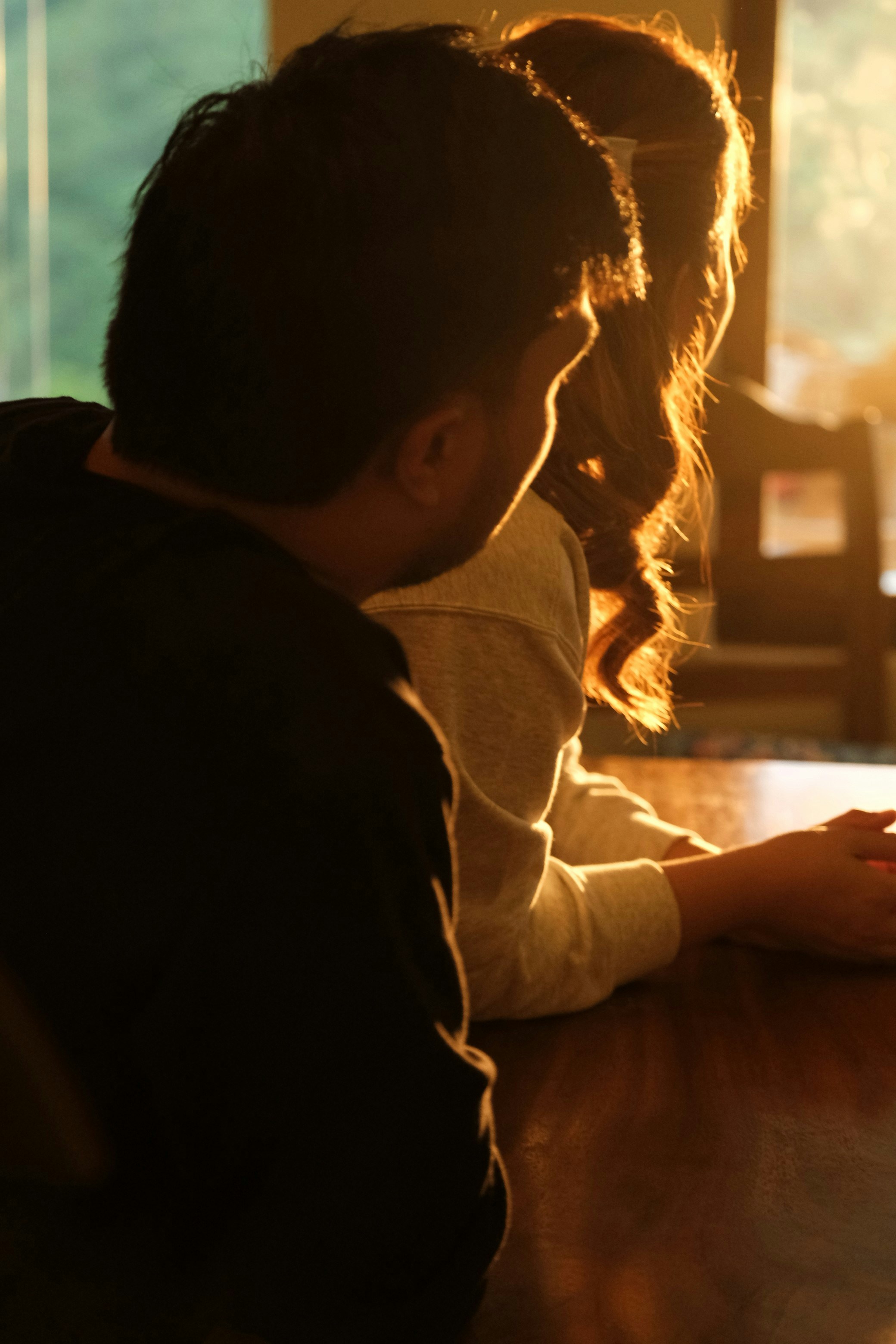 to your sunshine | Couple silhouetted against warm sunset light indoors.