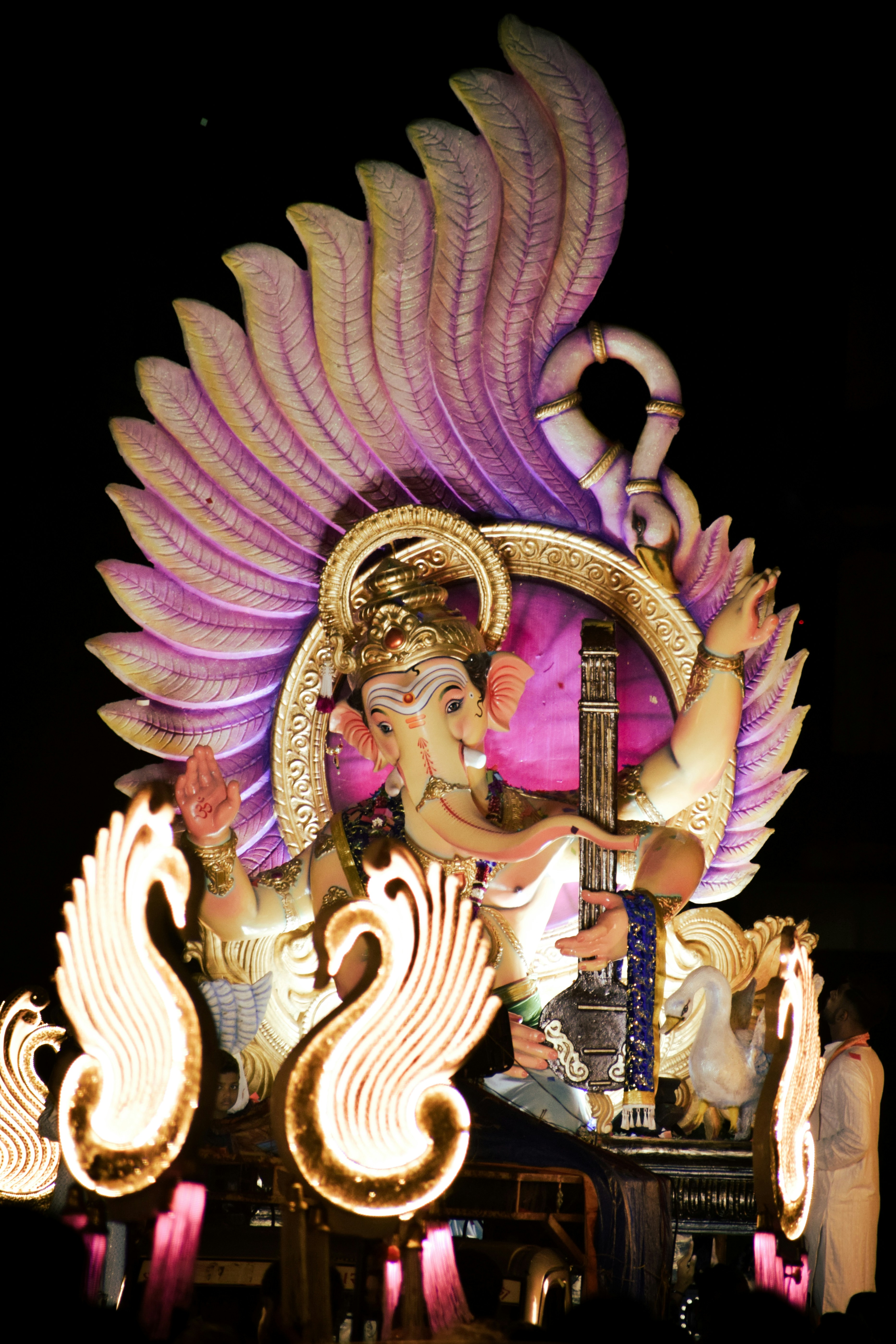 Elaborate ganesha idol with peacock feathers and lights
