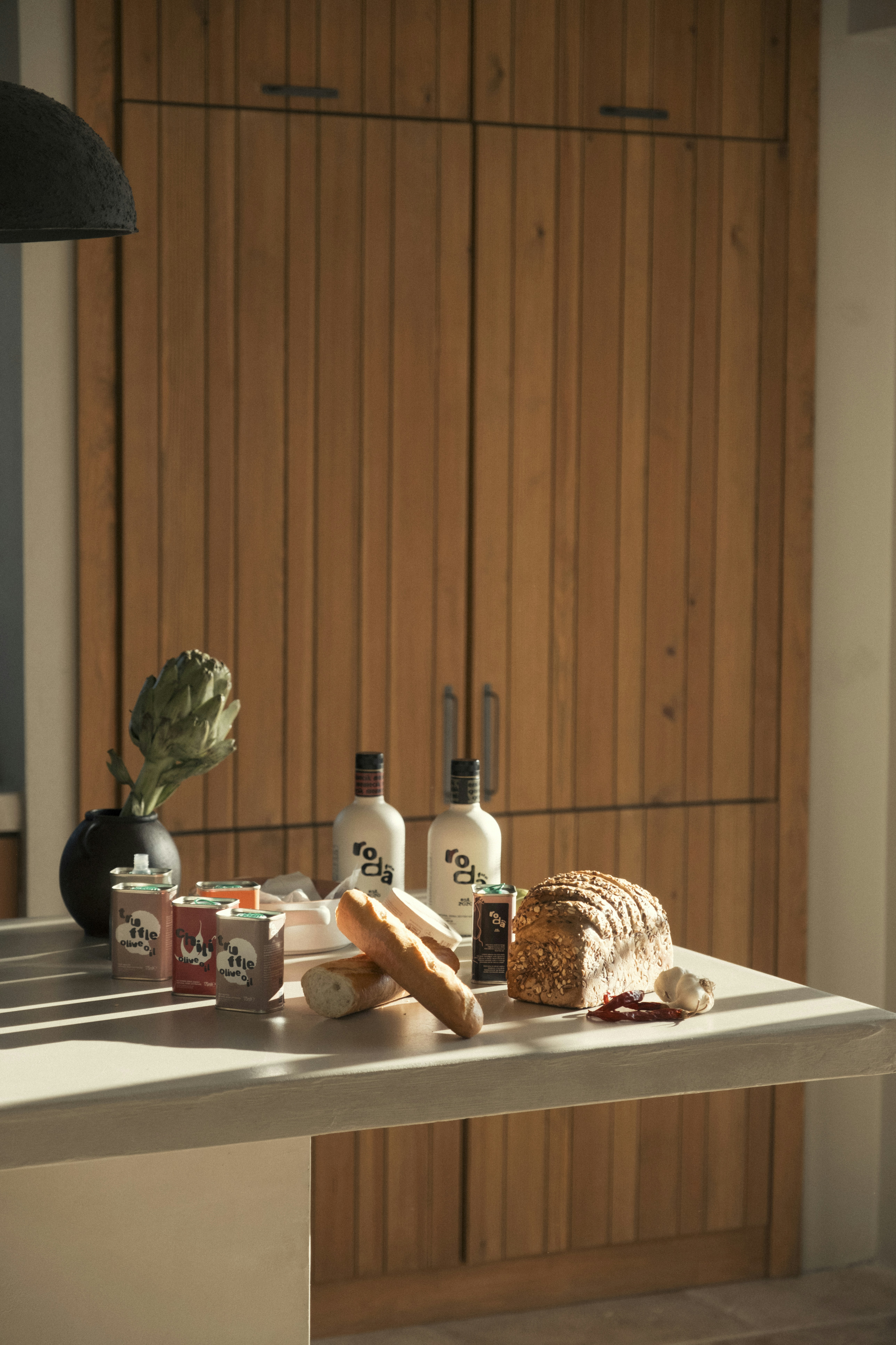 Sunlit Bread and Bottles on a Minimal Kitchen Table