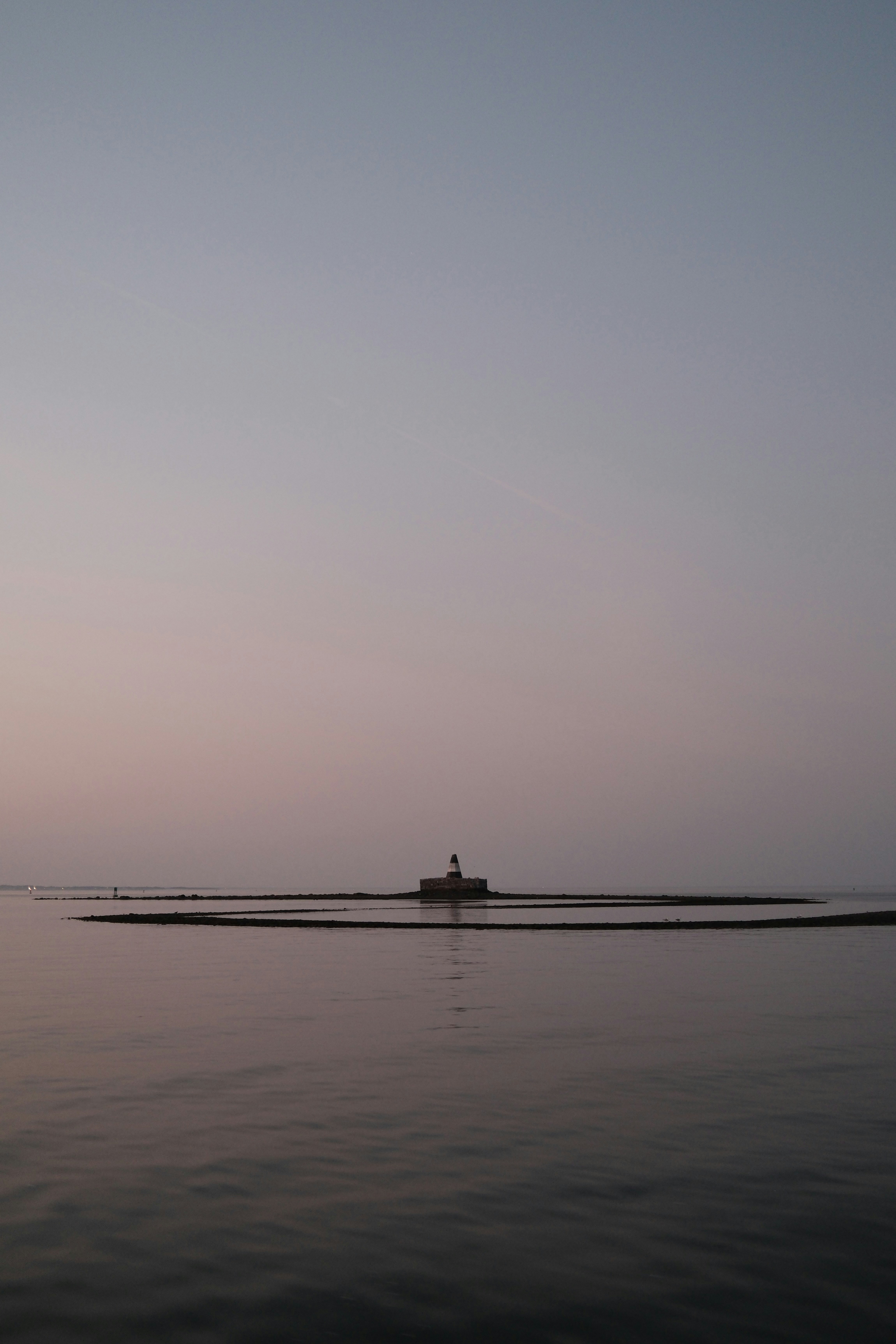 Circular Breakwater at Dusk: A Quiet Sentinel on Still Waters