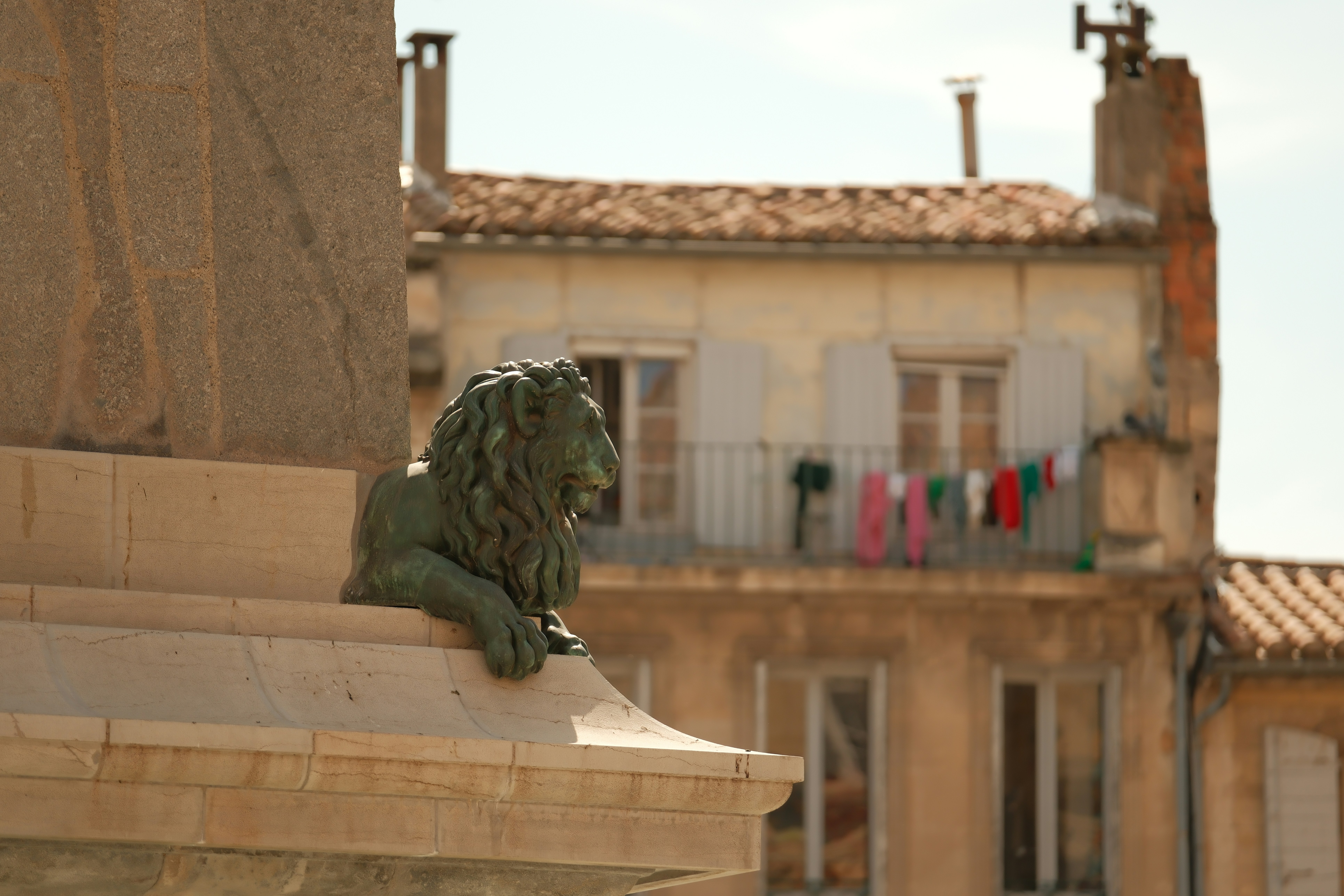Patinaed Lion Over a Sunlit, Weathered Piazza