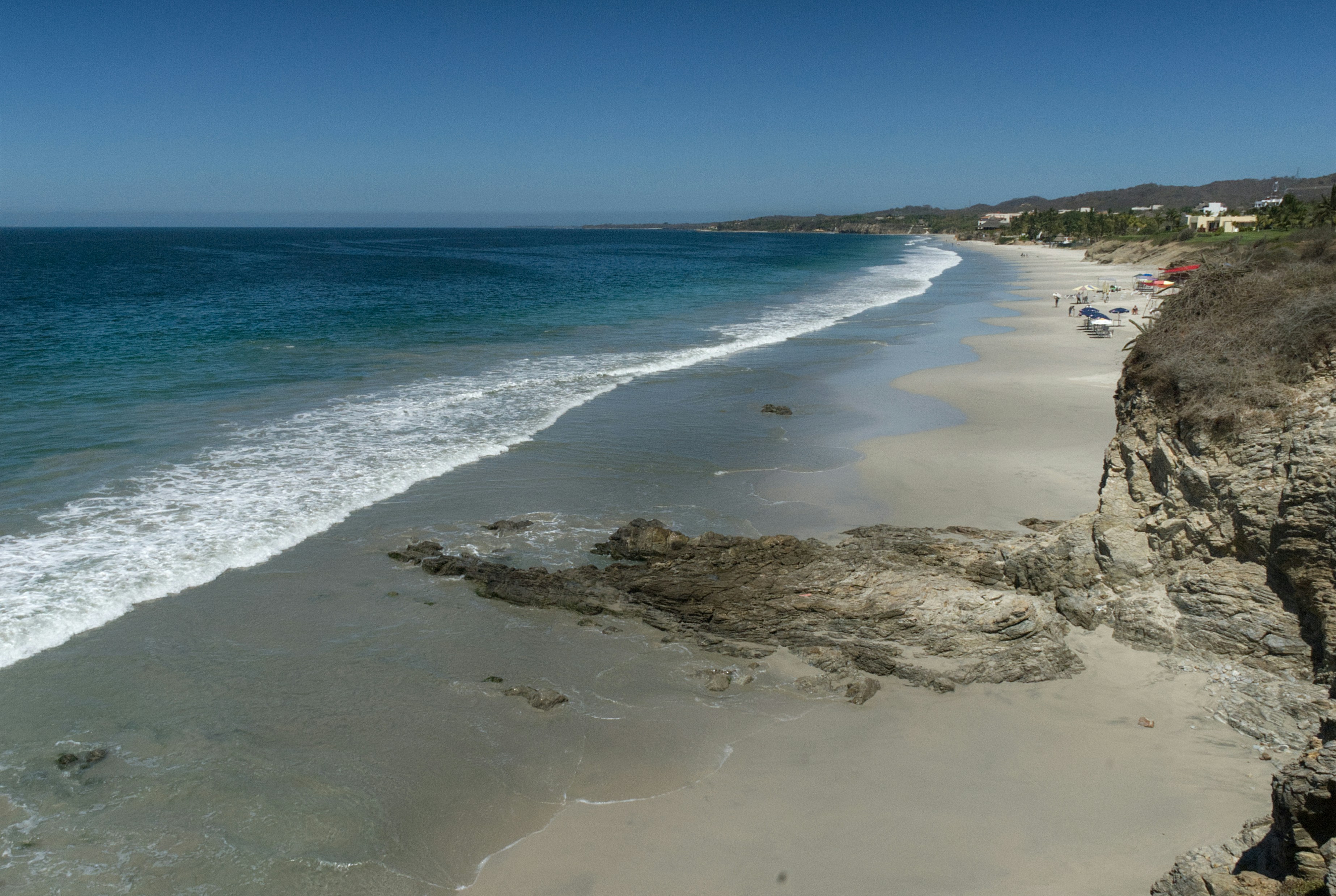 Destiladeras beach on Banderas Bay's north coast | A scenic beach with waves crashing on shore.