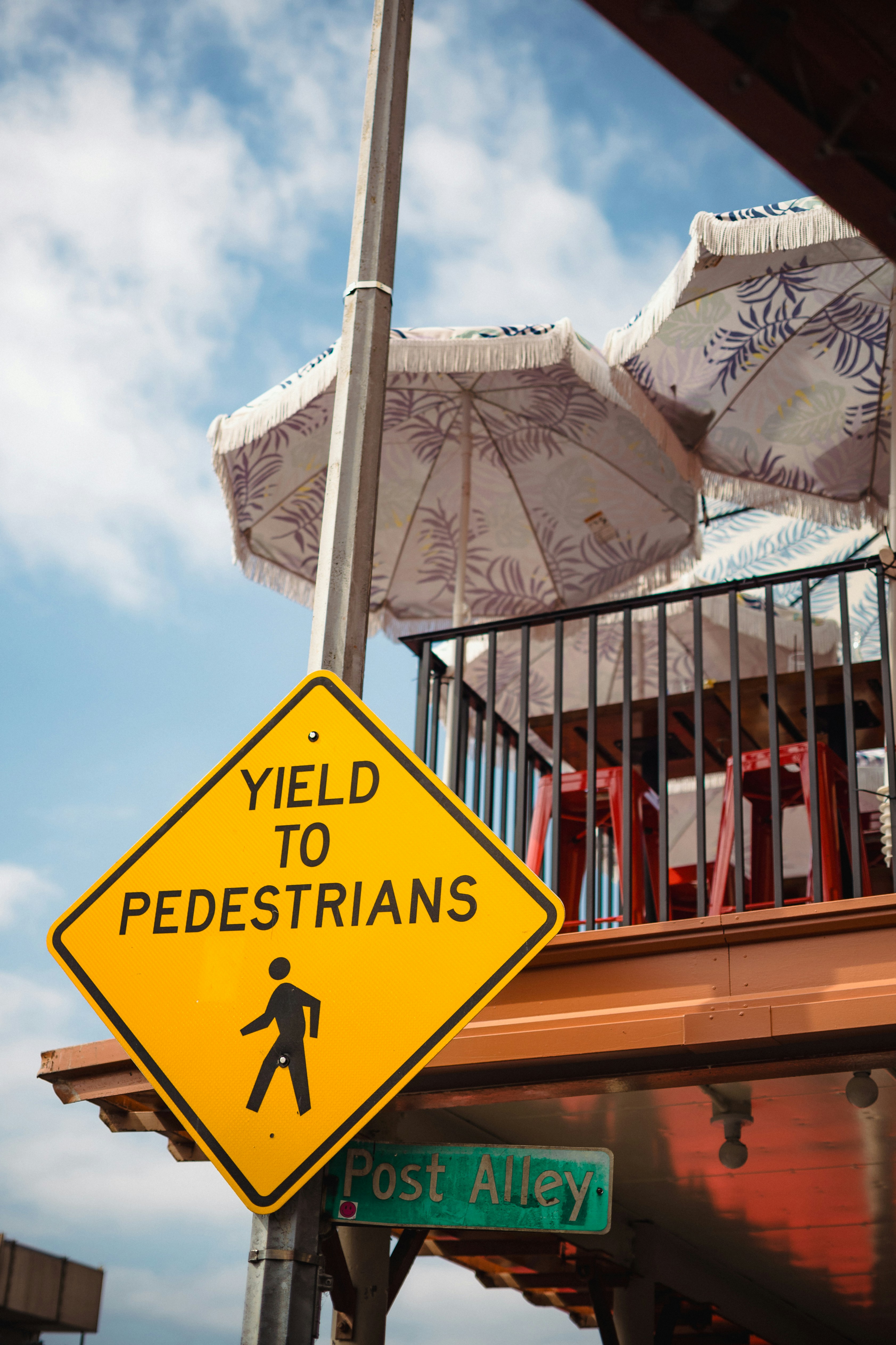 Yellow Pedestrian Caution Overlooking a Sunny Balcony