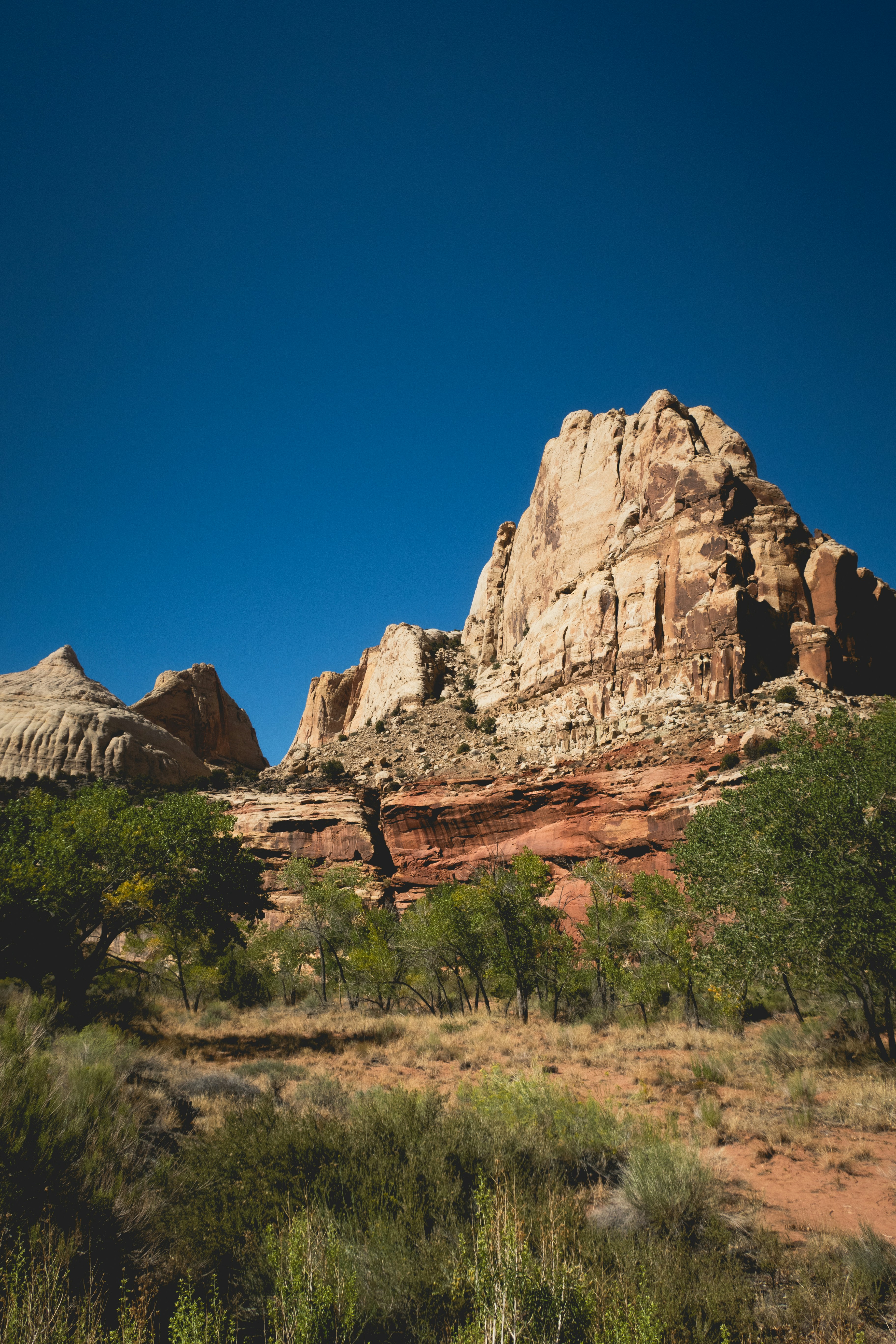 Layered sandstone cliffs under a clear blue sky.