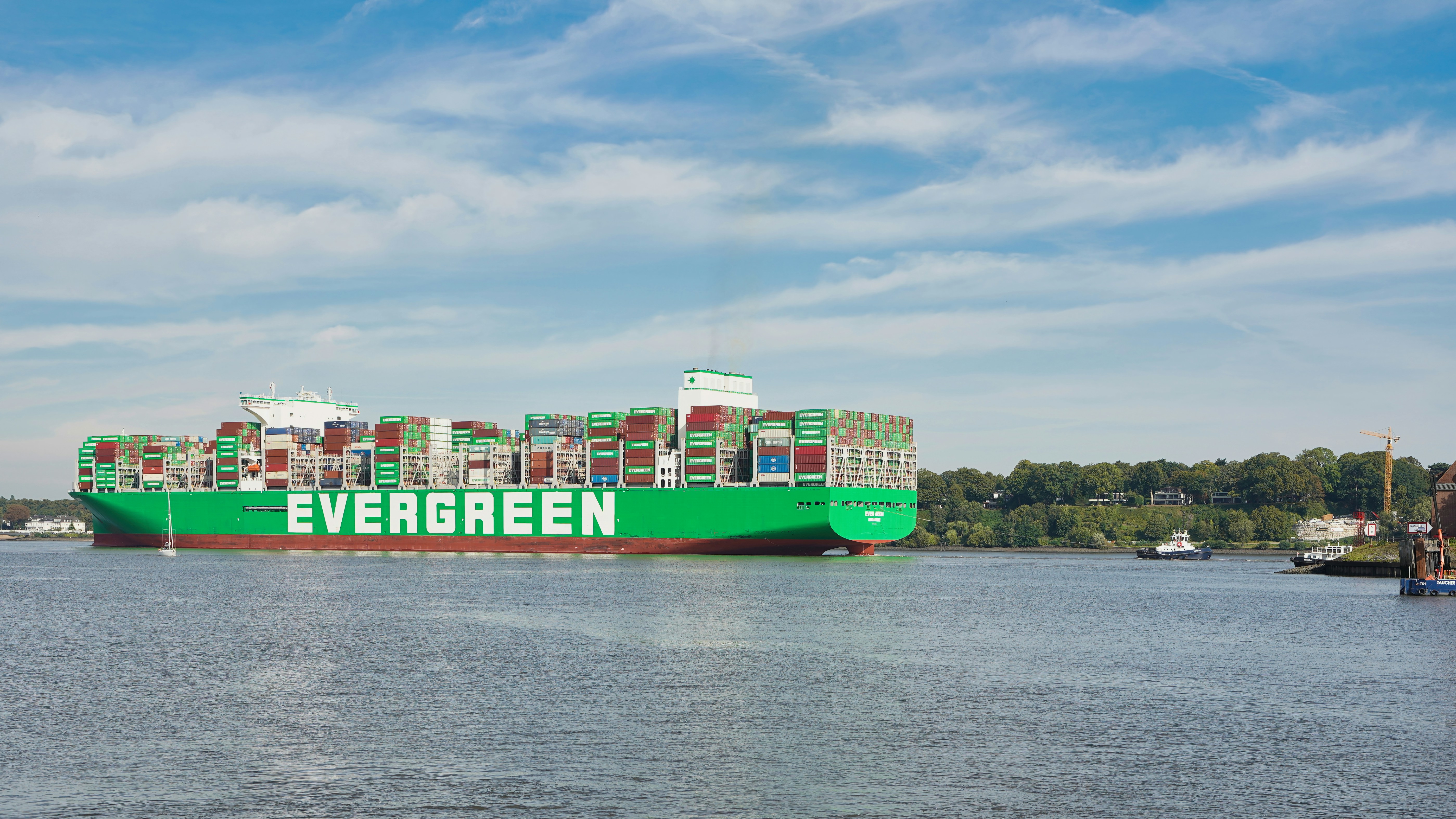 Green Giant on the River: Evergreen Container Vessel Against a Clear Sky