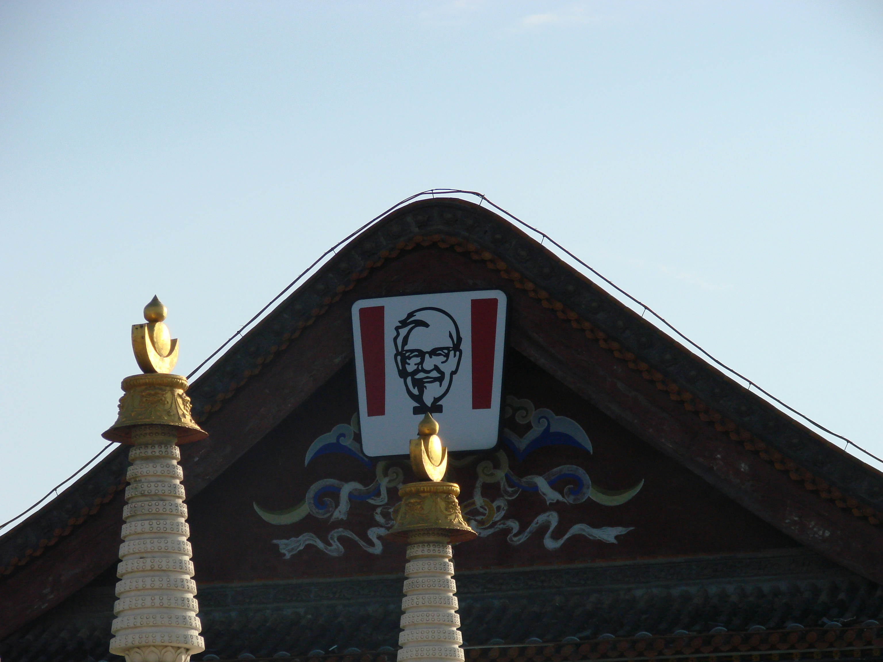 Kfc logo on a traditional building rooftop
