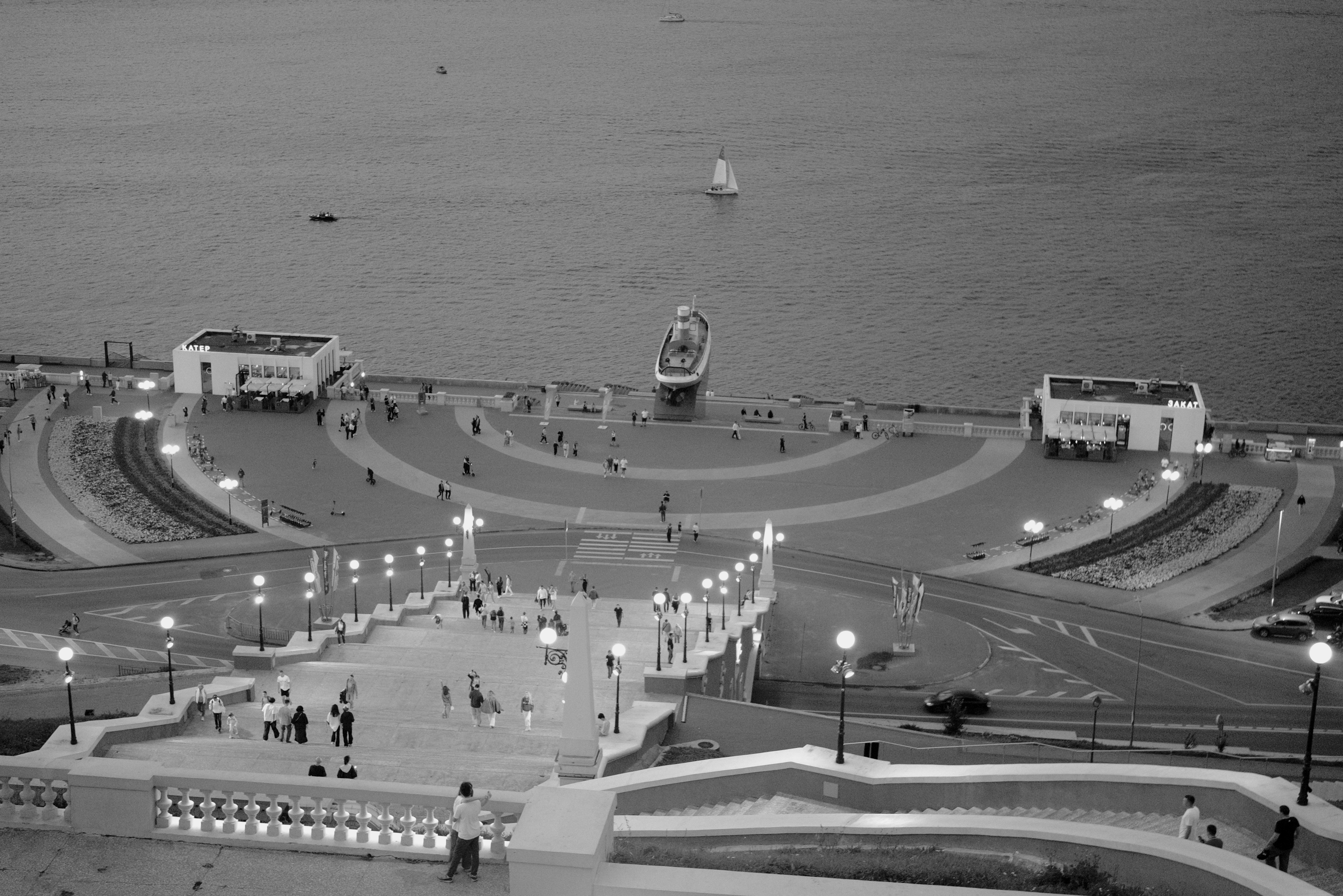 Circular Promenade at Dusk: Lamps, Steps, and a Quiet Sea