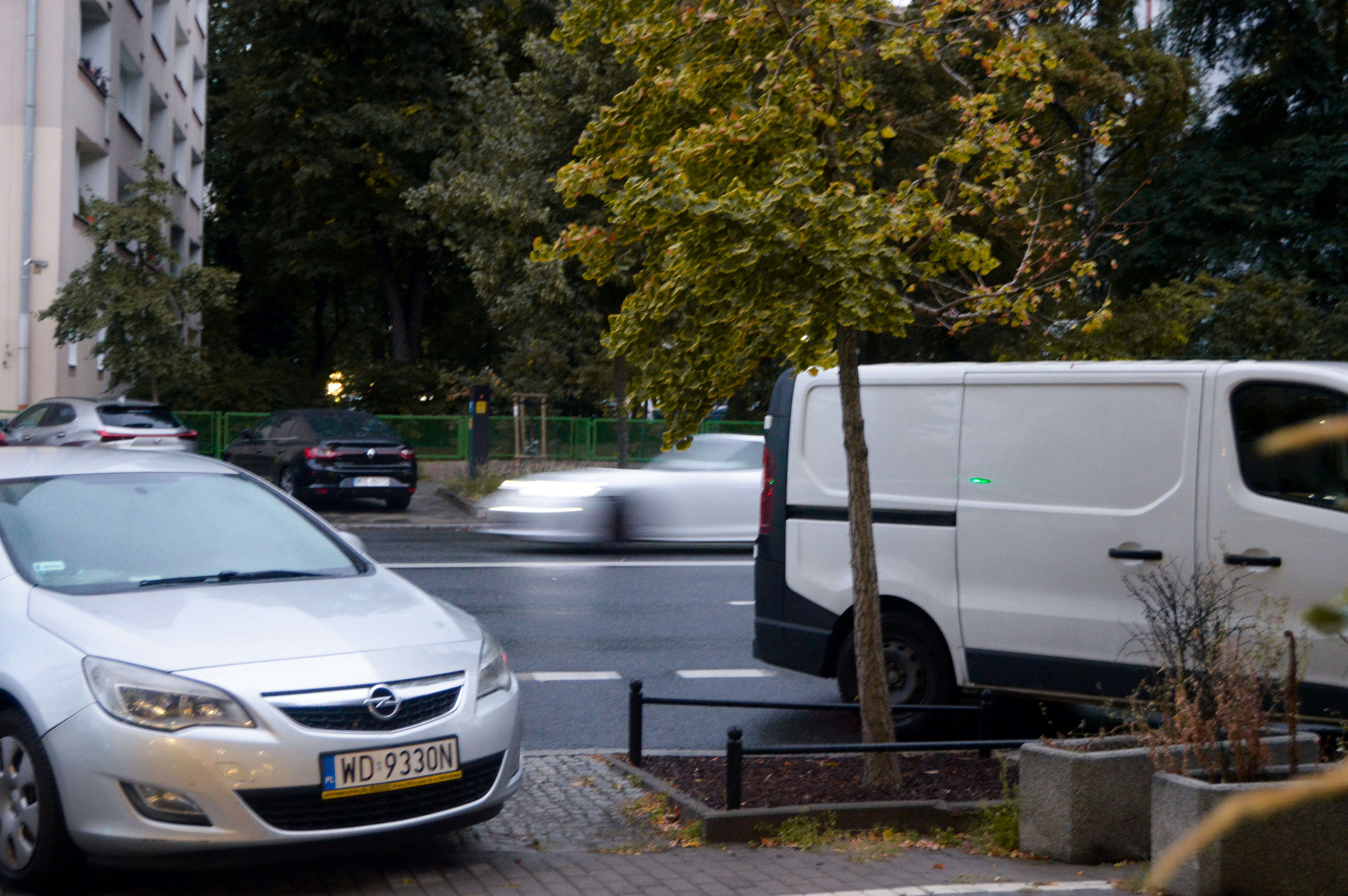 Urban Street Scene: The White Van Bordered by Moving Life