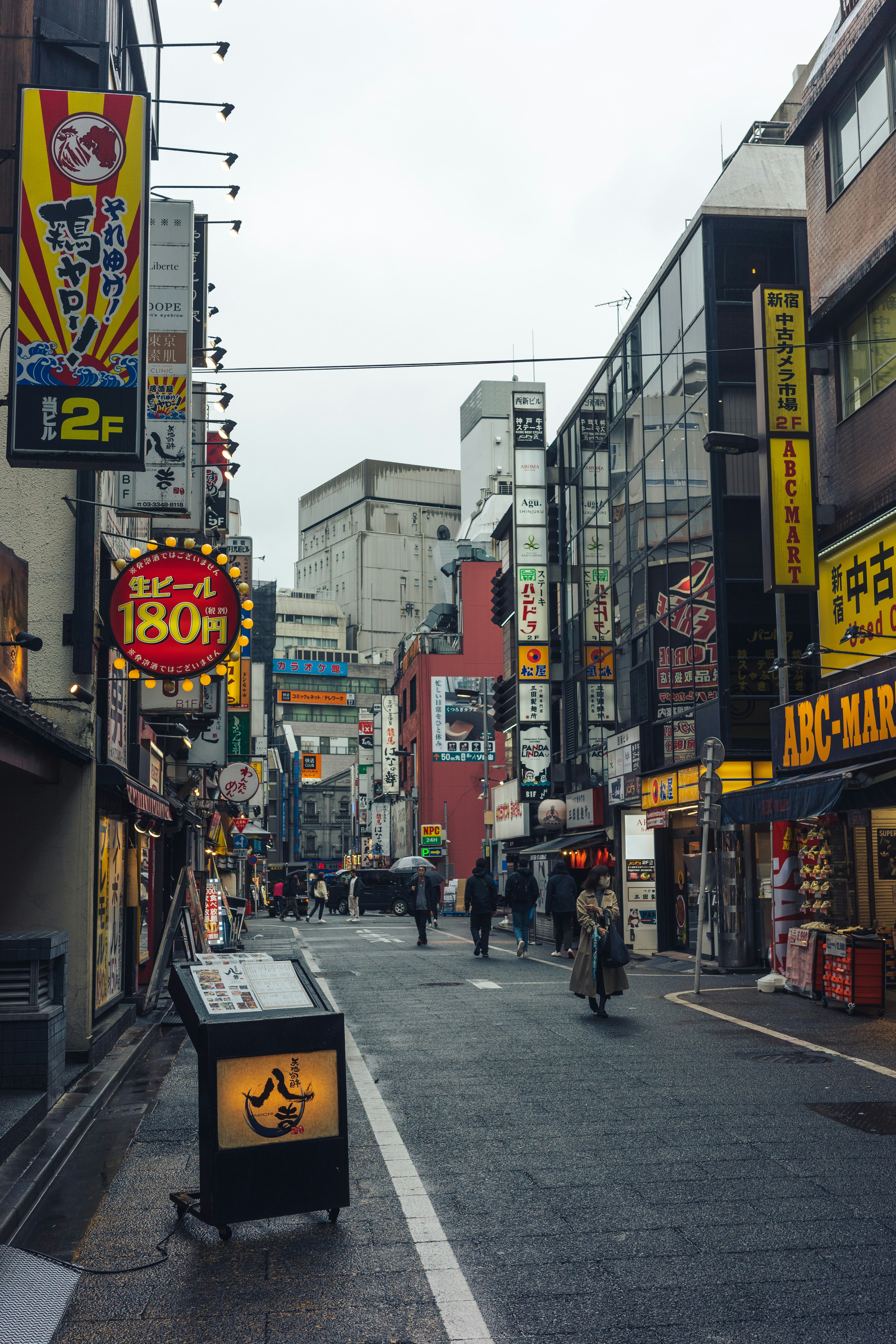 Busy street with shops and signs in japan.