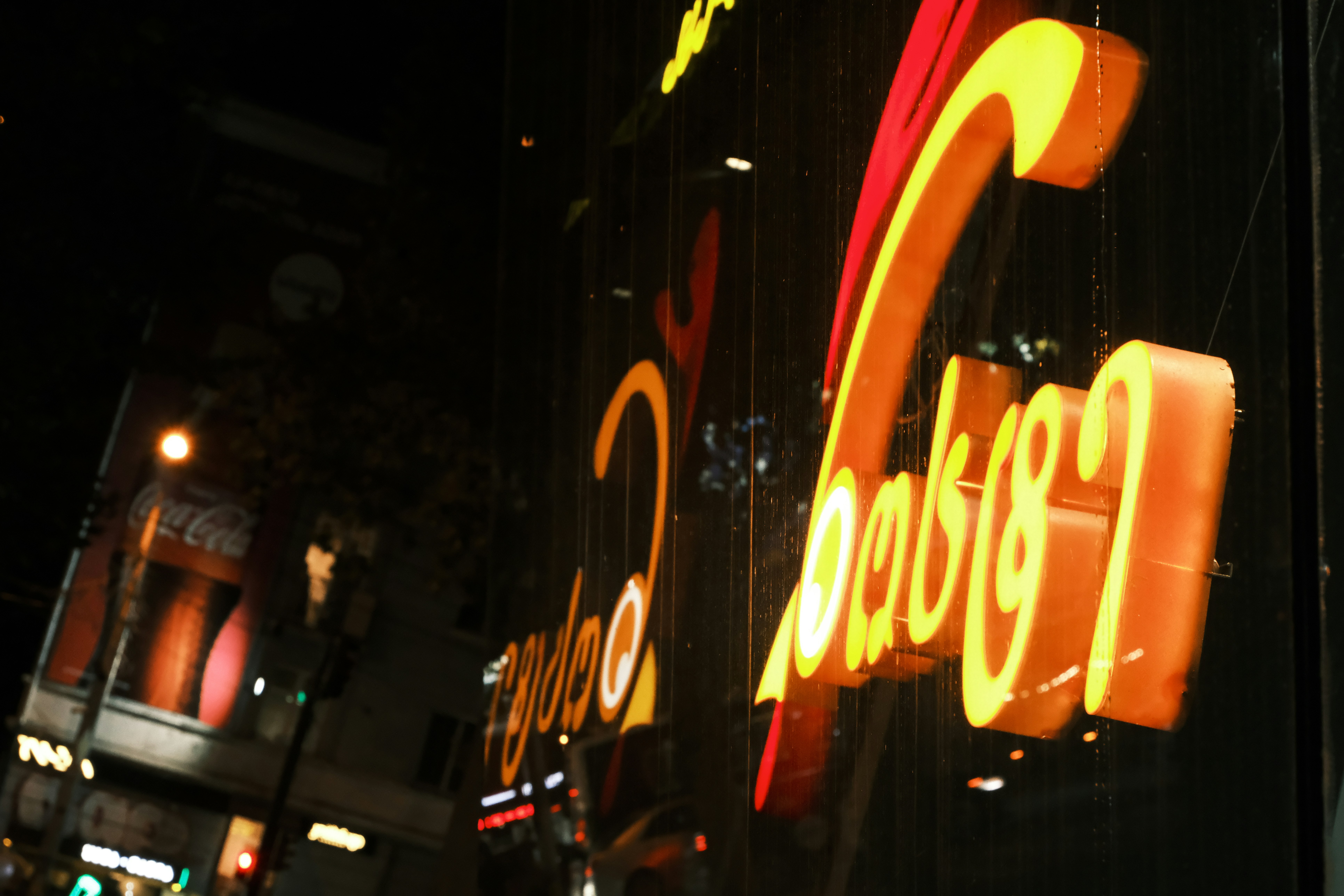 Bright neon sign for a bakery at night