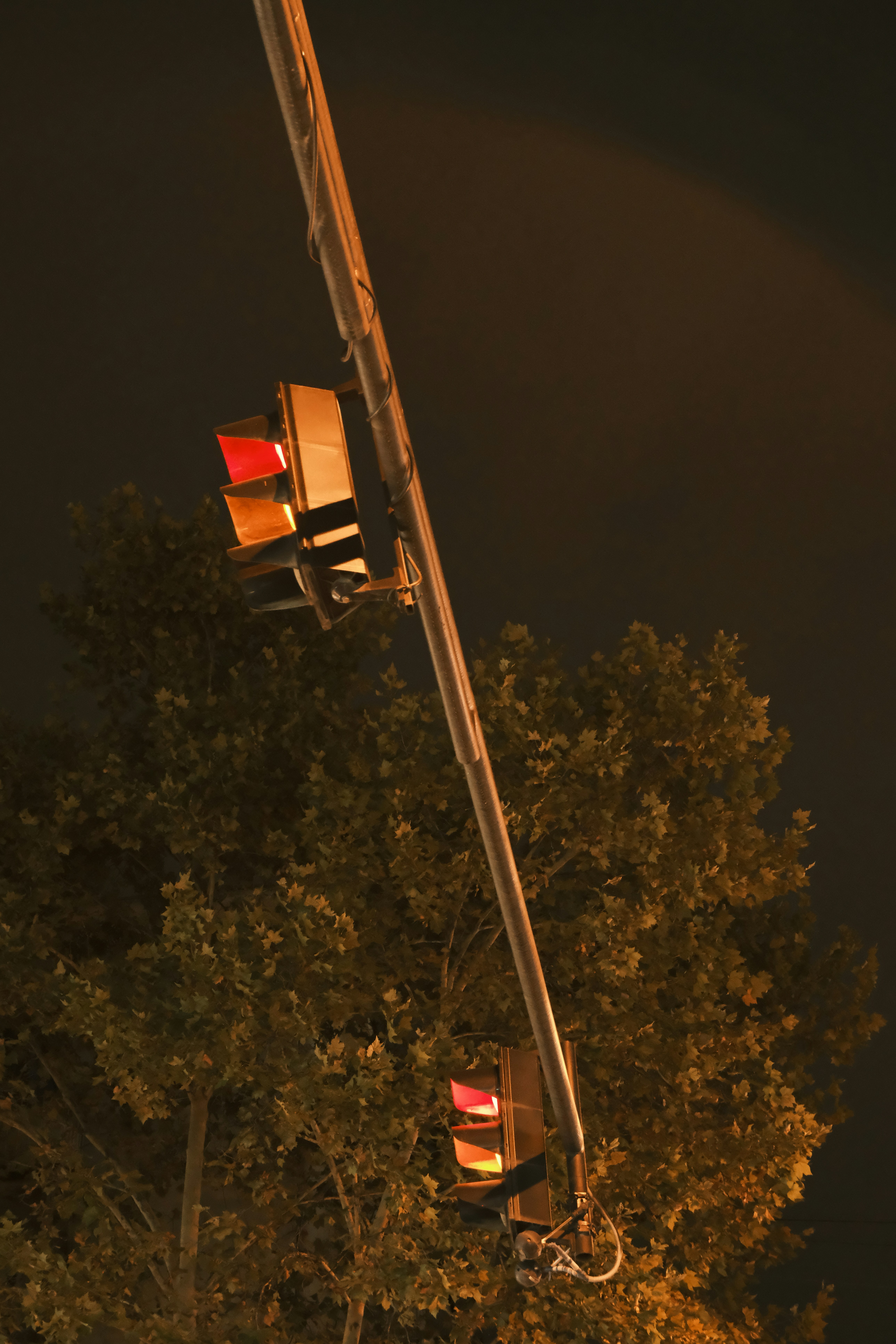 Two traffic lights glowing at night