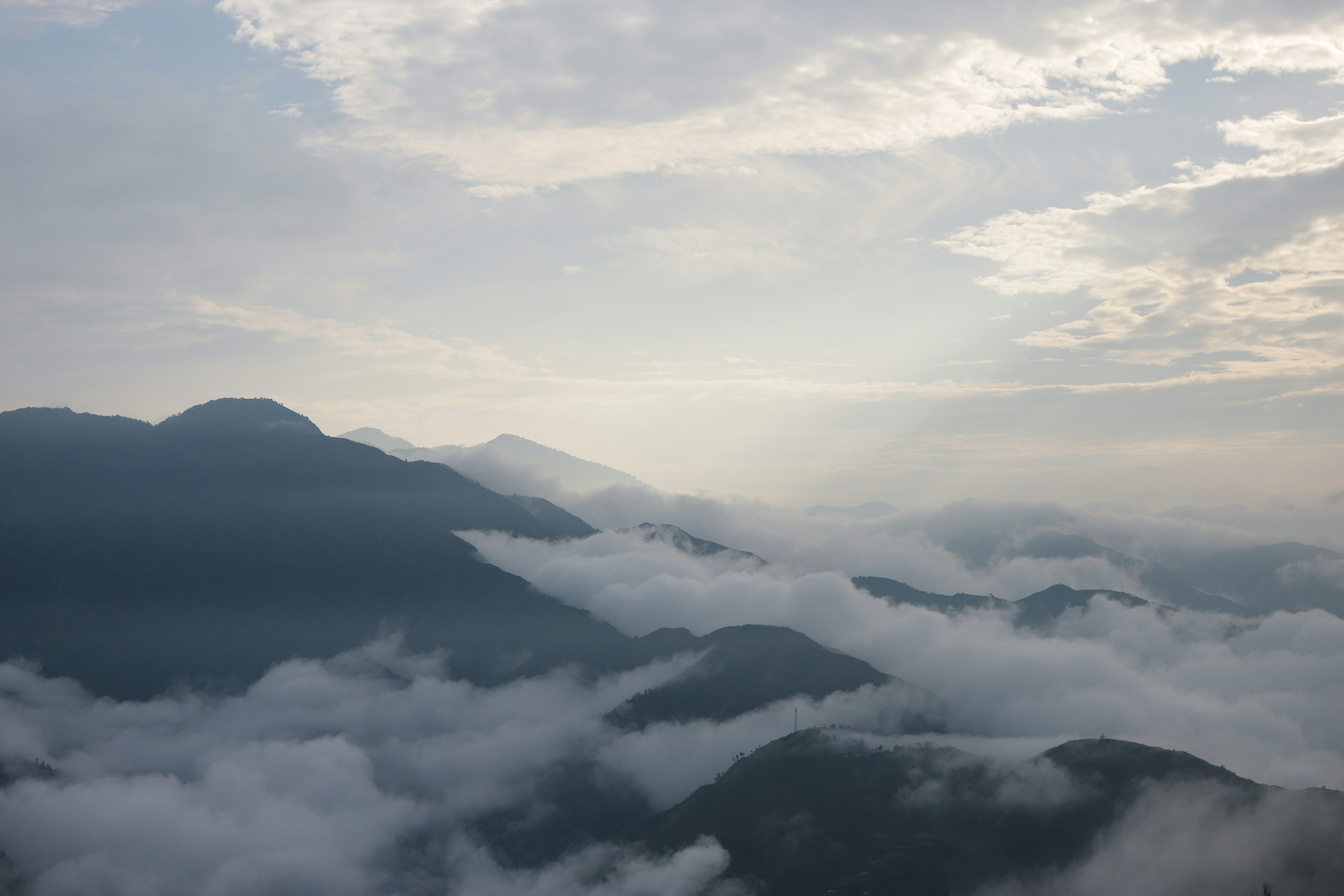 Veil of Mist Over Majestic Peaks