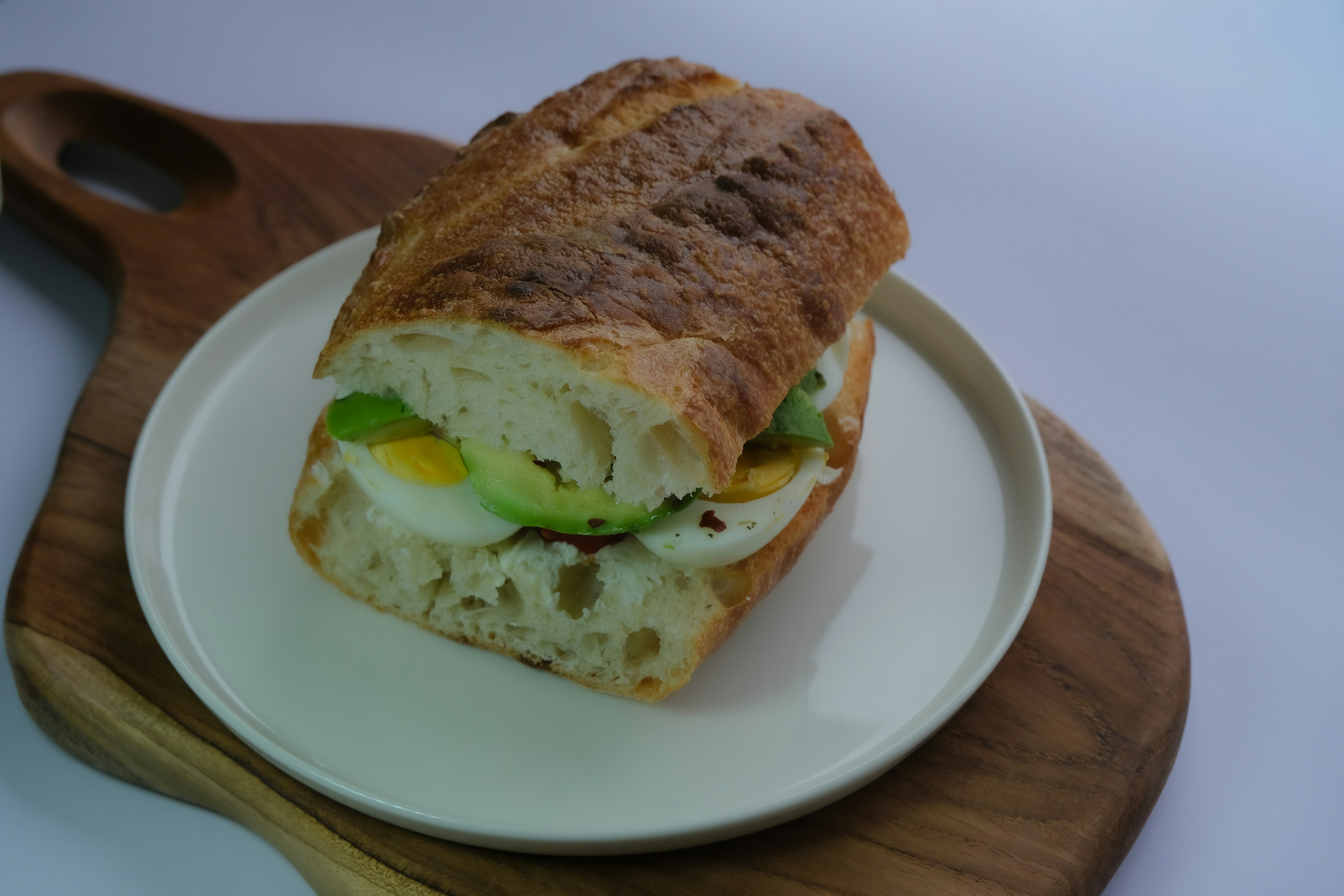 Crusty Rustic Duo: A sandwich on a sunlit wooden board