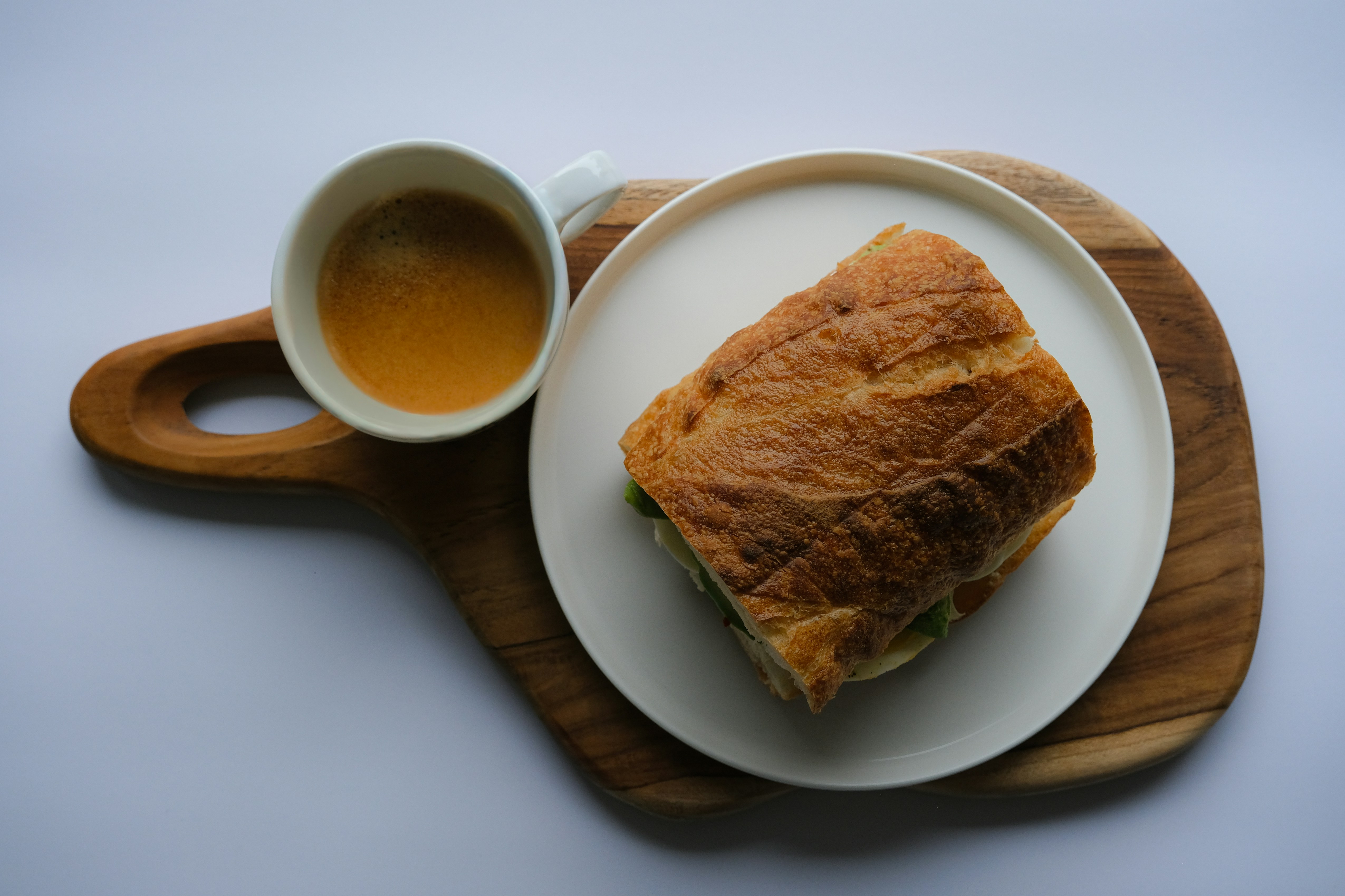 Sandwich and tea on a wooden board