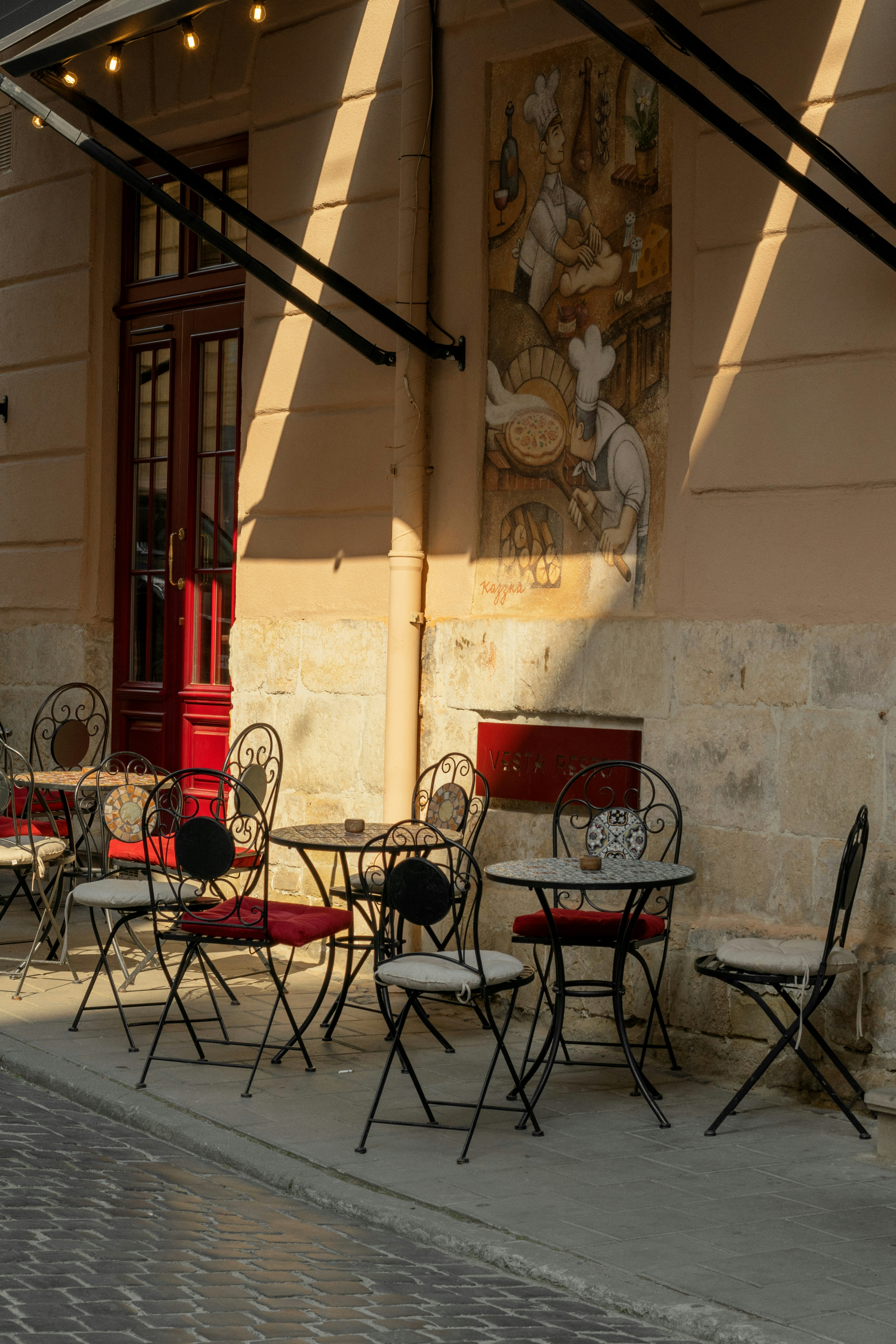 Red Door Café in Dappled Light: Quiet Geometry of a Sunlit Street