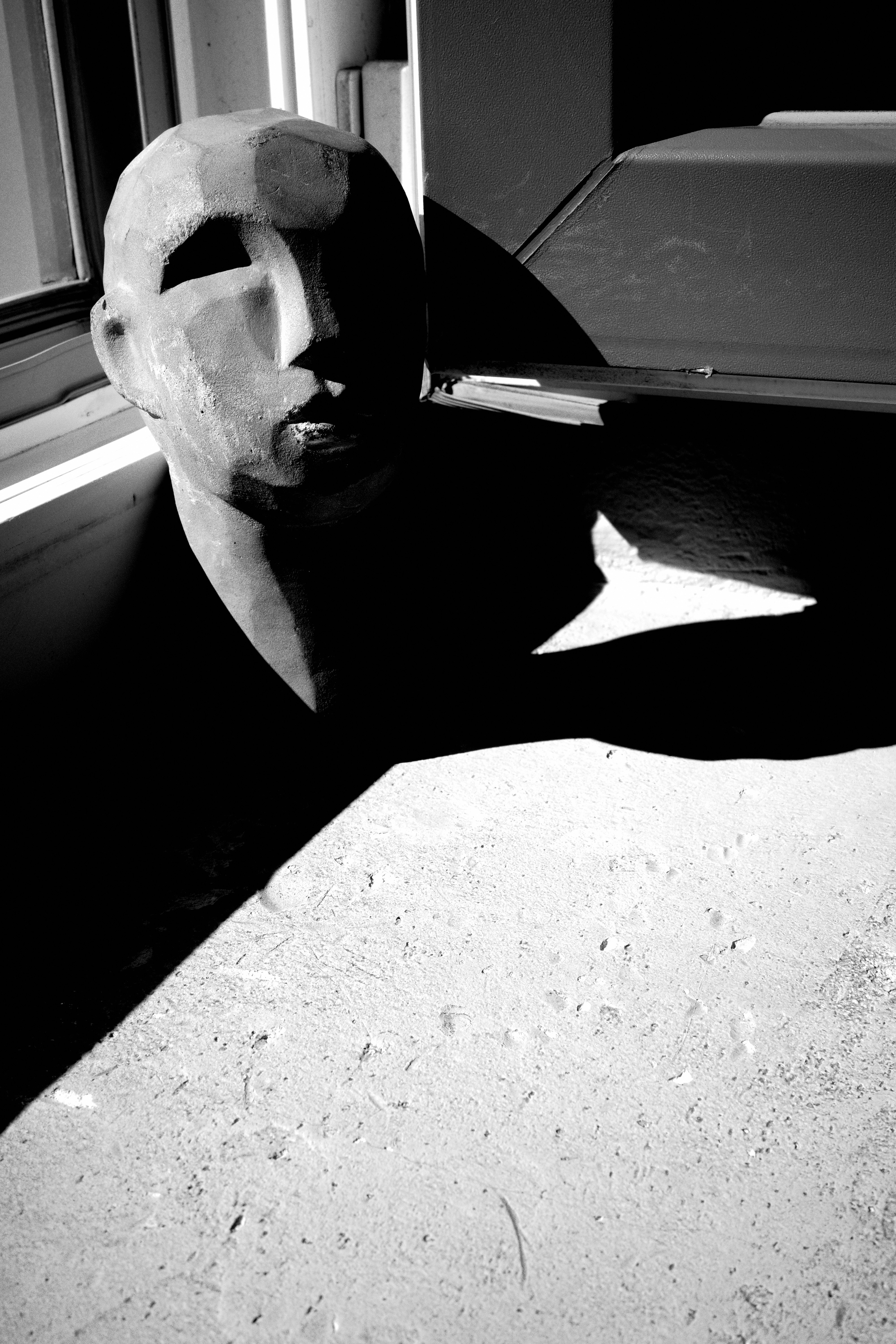Chiaroscuro Facet: A Geometric Bust in Window Light