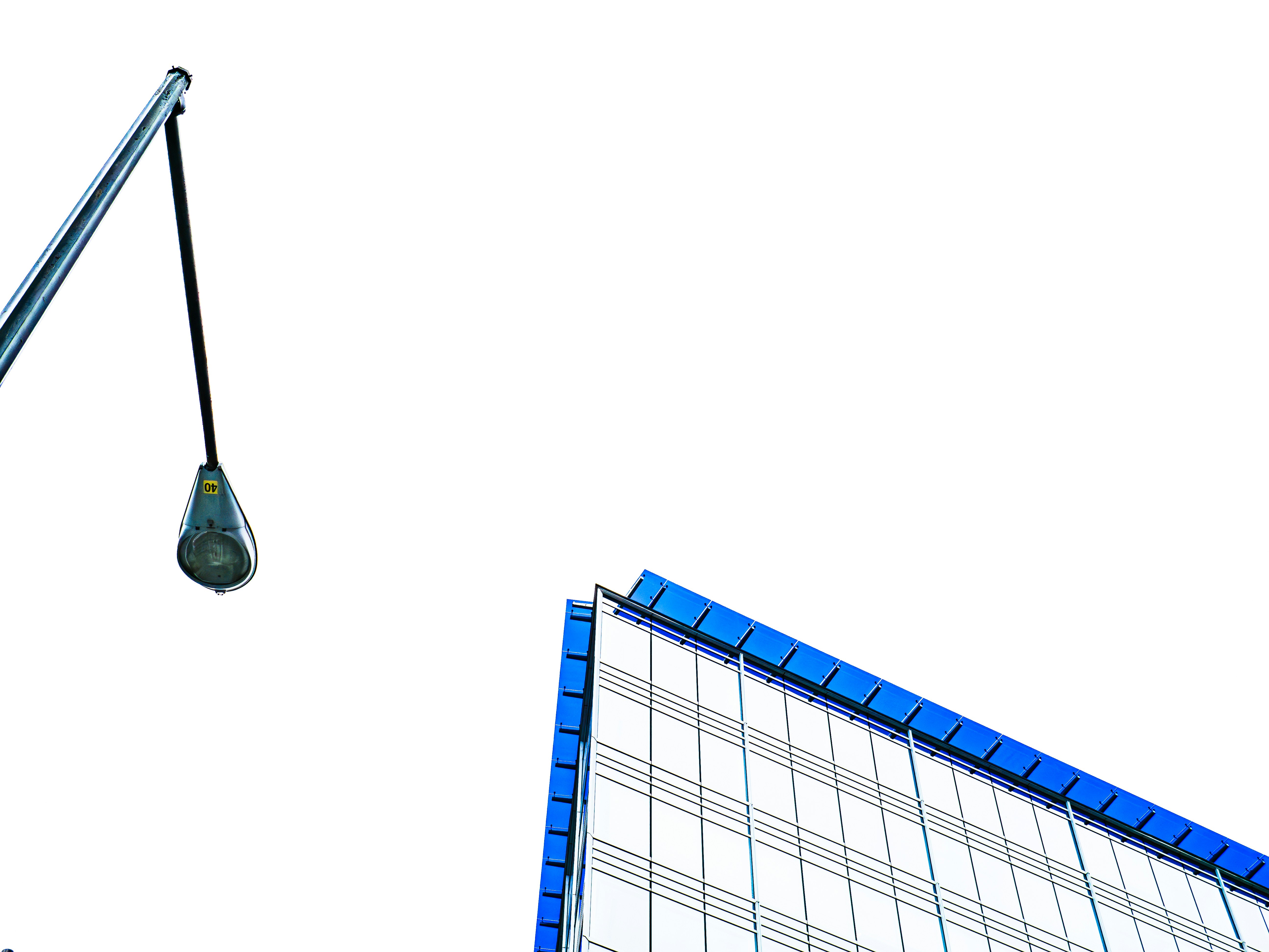 A modern building and a street lamp | Modern building with blue trim and street lamp