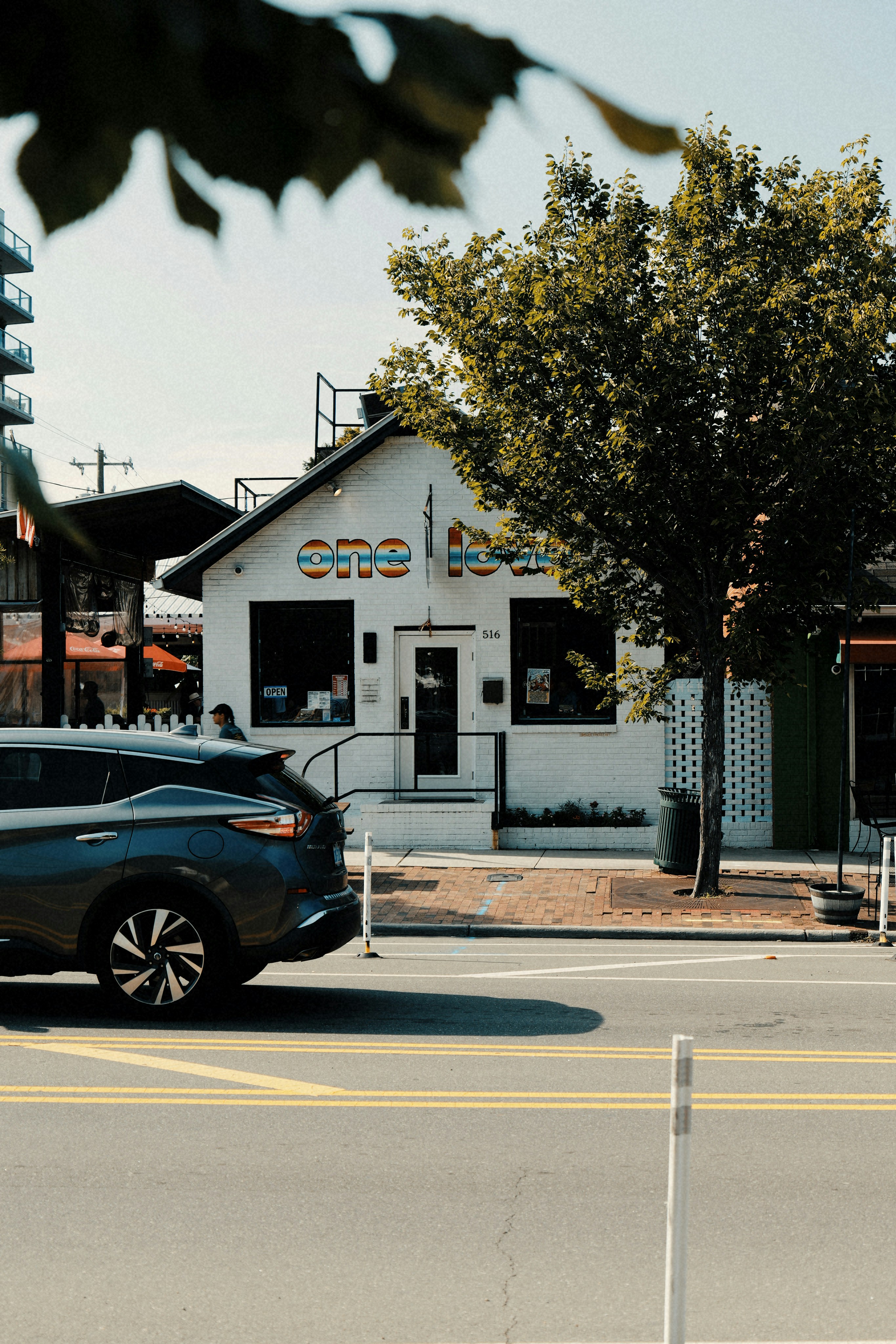 The One Life Storefront Framed by Dappled Urban Light