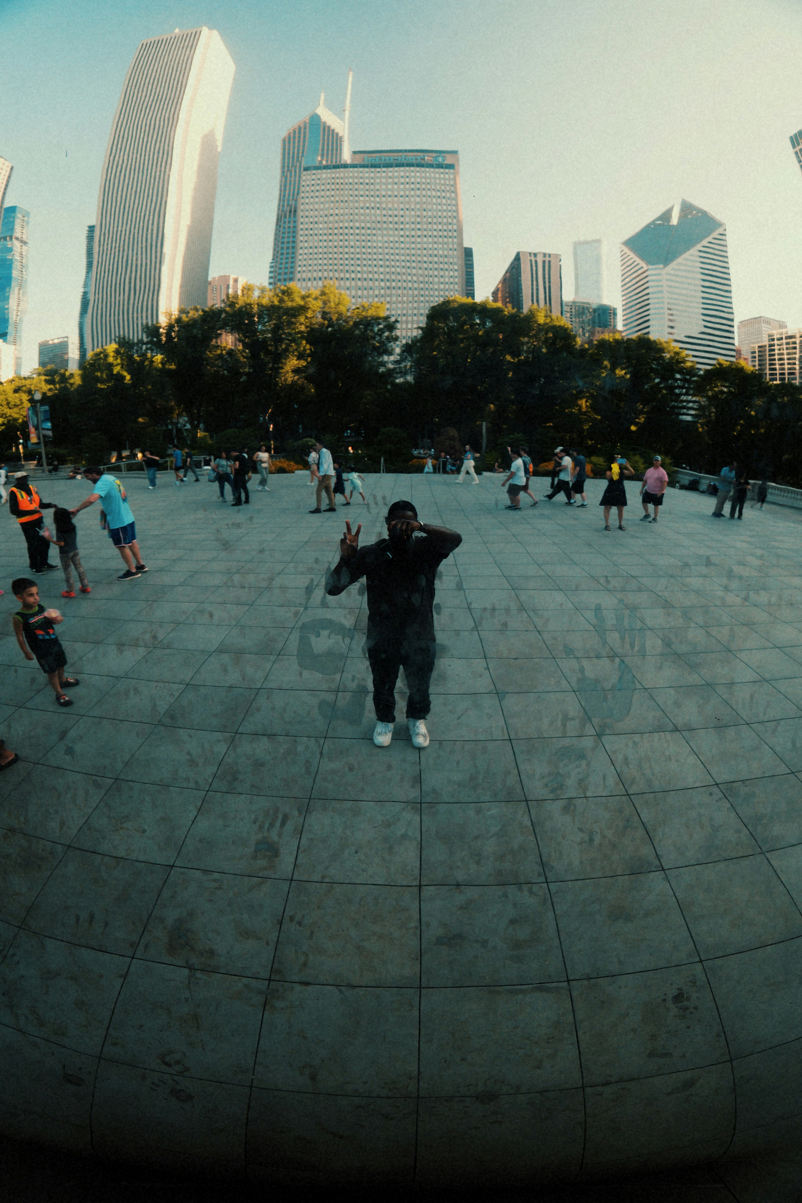 Center of the City Grid: A fisheye self-portrait beneath glass towers