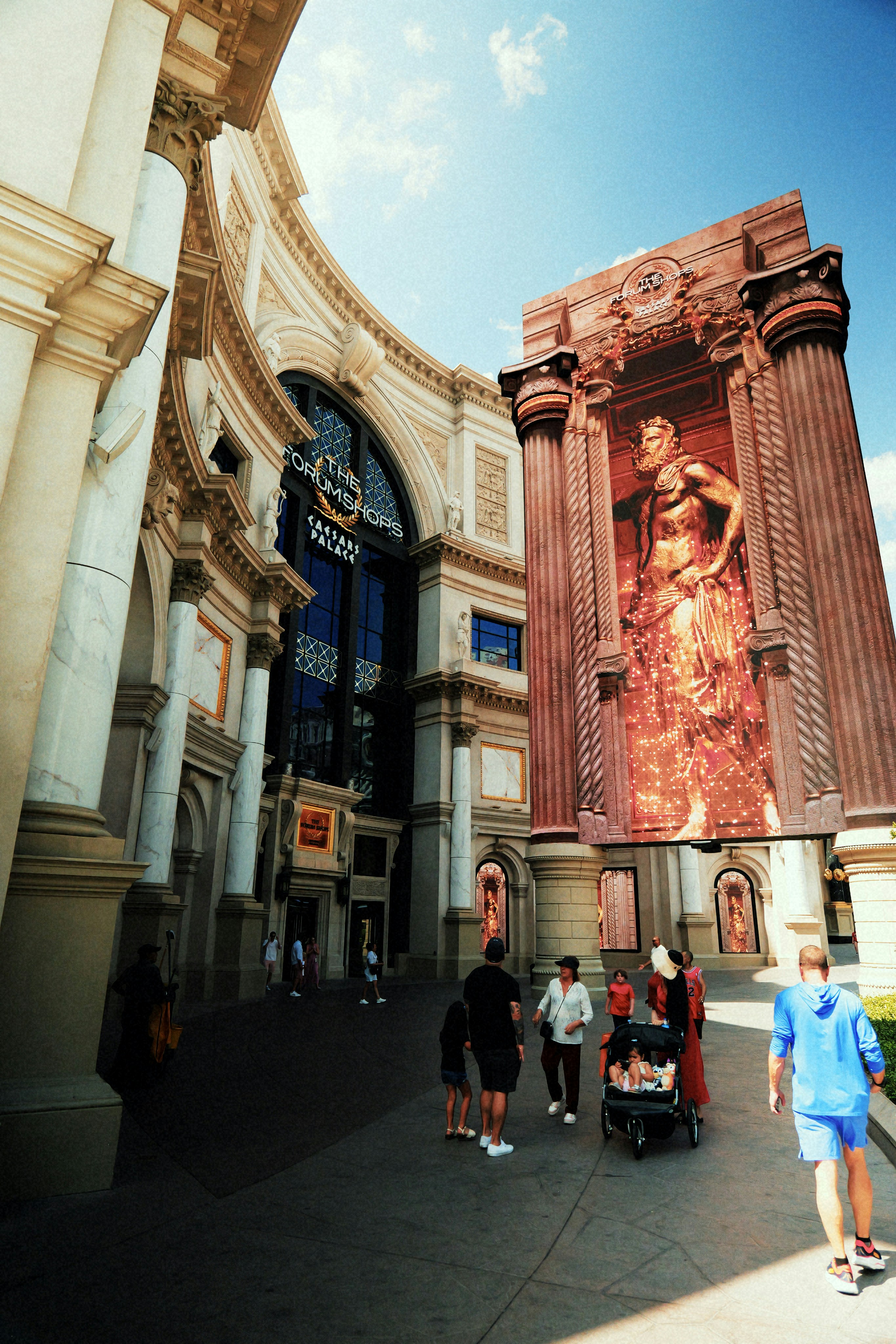 Flame-Relief Monument Framed by Classical Arches in a Sunlit Plaza