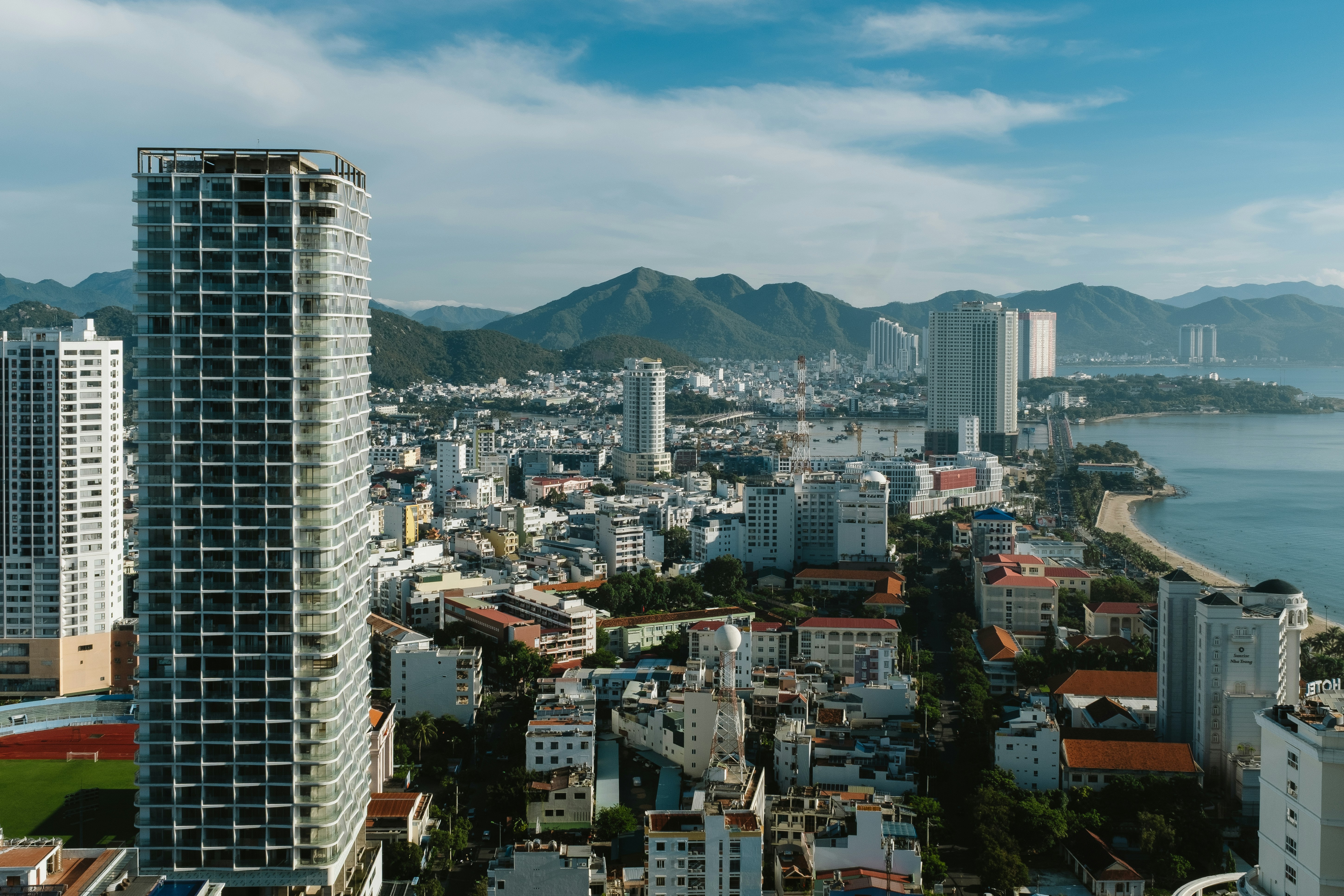 Coastal city skyline with mountains in background