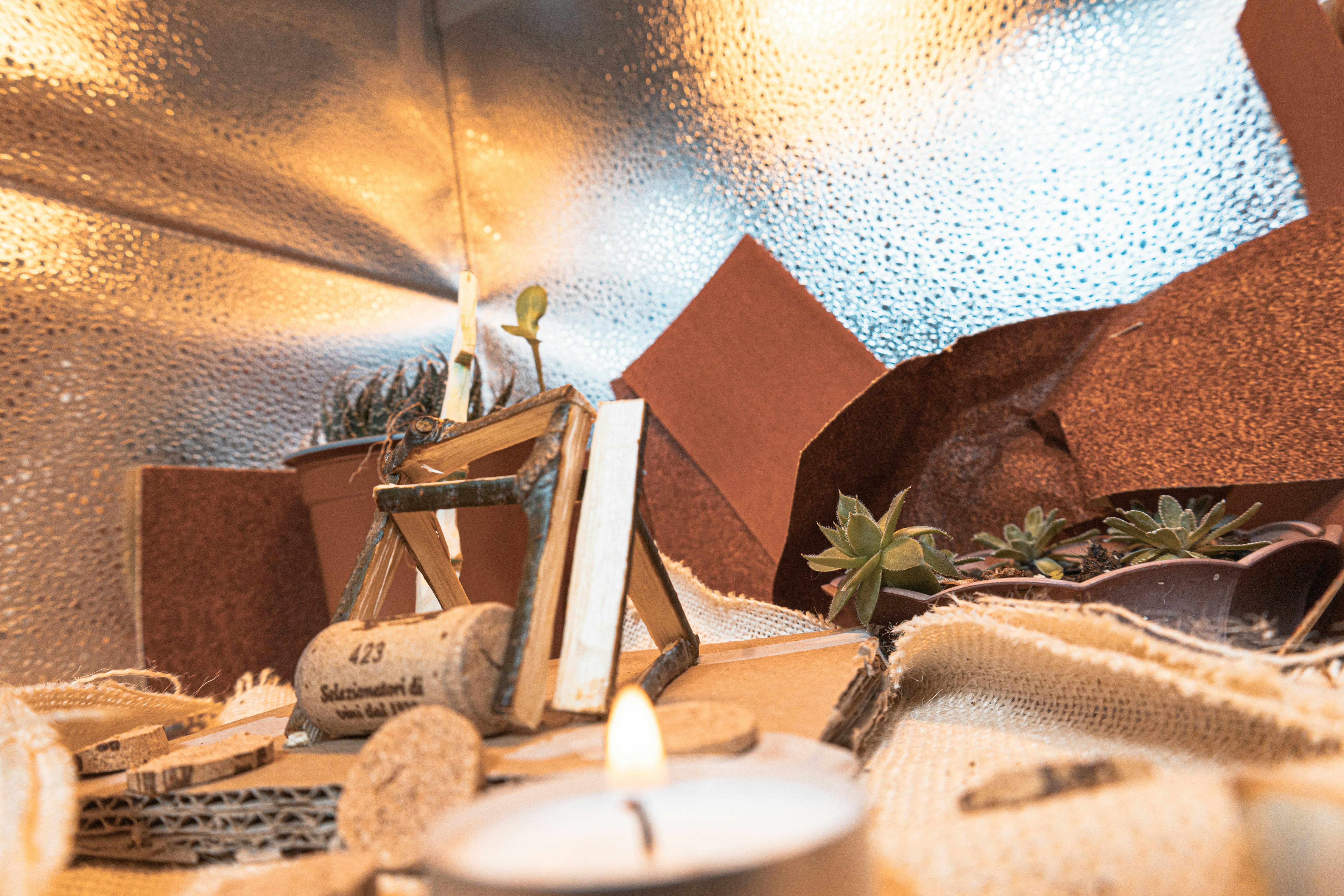 Candlelit Miniature Diorama: A Tiny Boat Among Books and Succulents