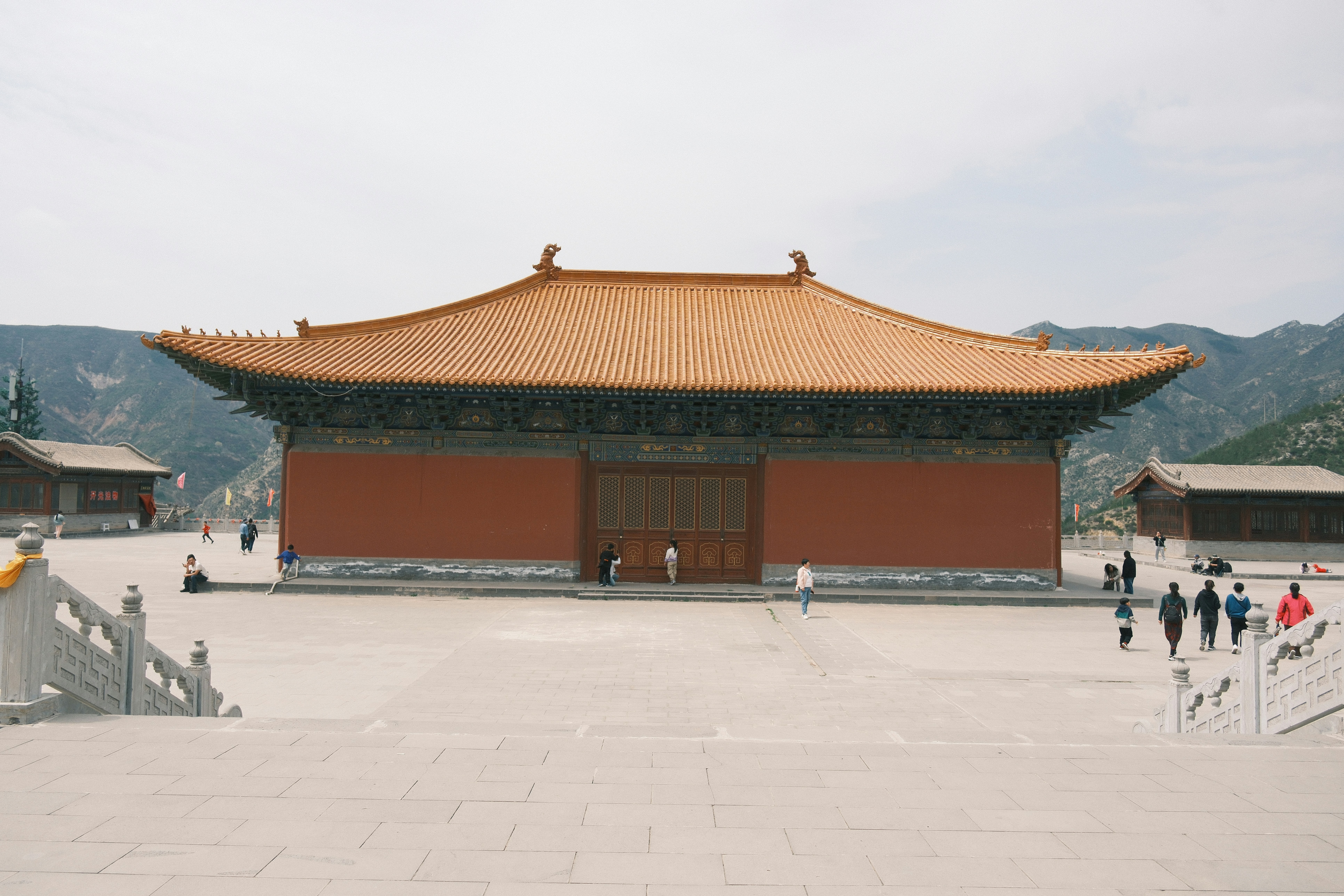 Traditional chinese temple with orange roof and red walls.