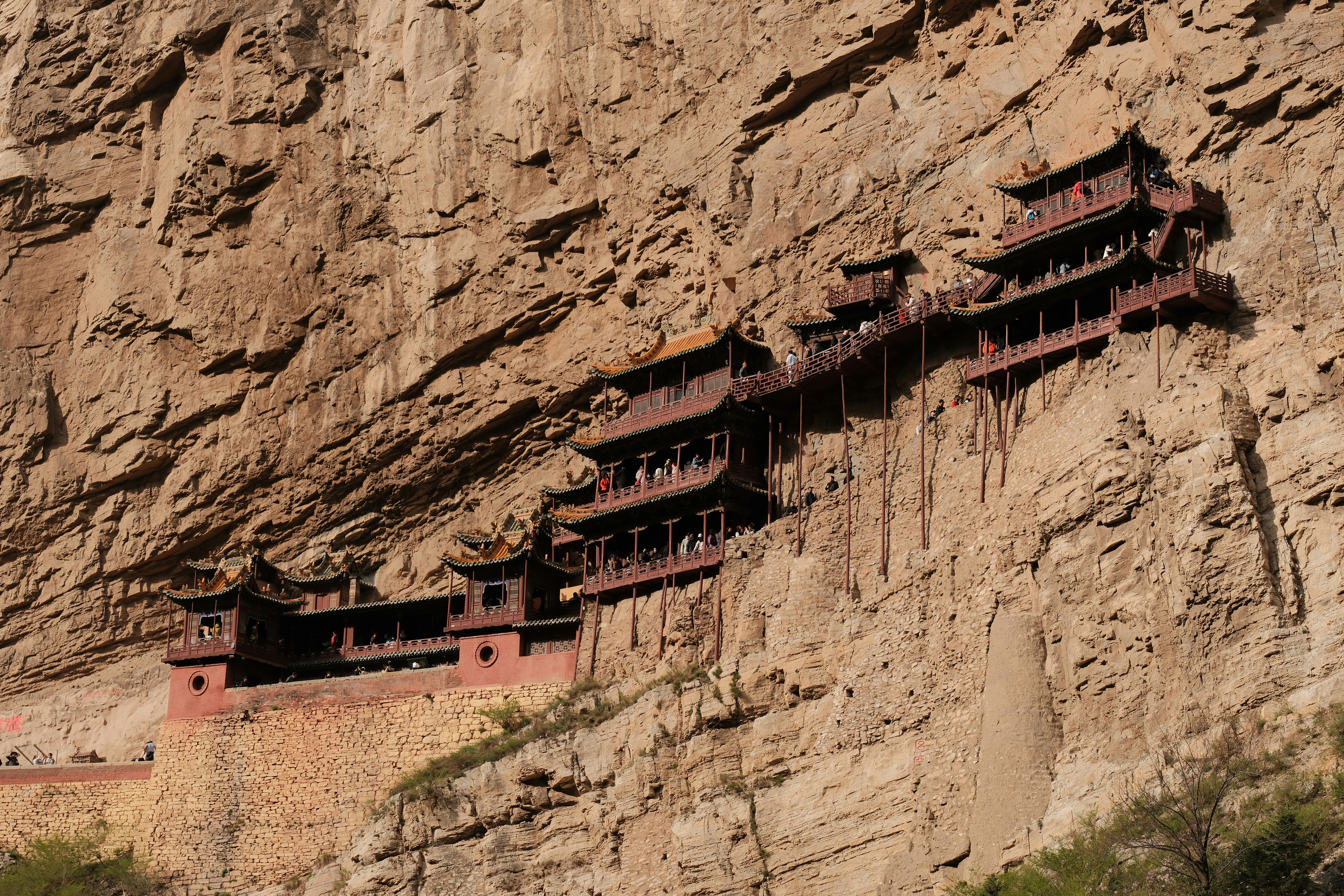 Terraced Red Pavilions Clinging to a Granite Cliff