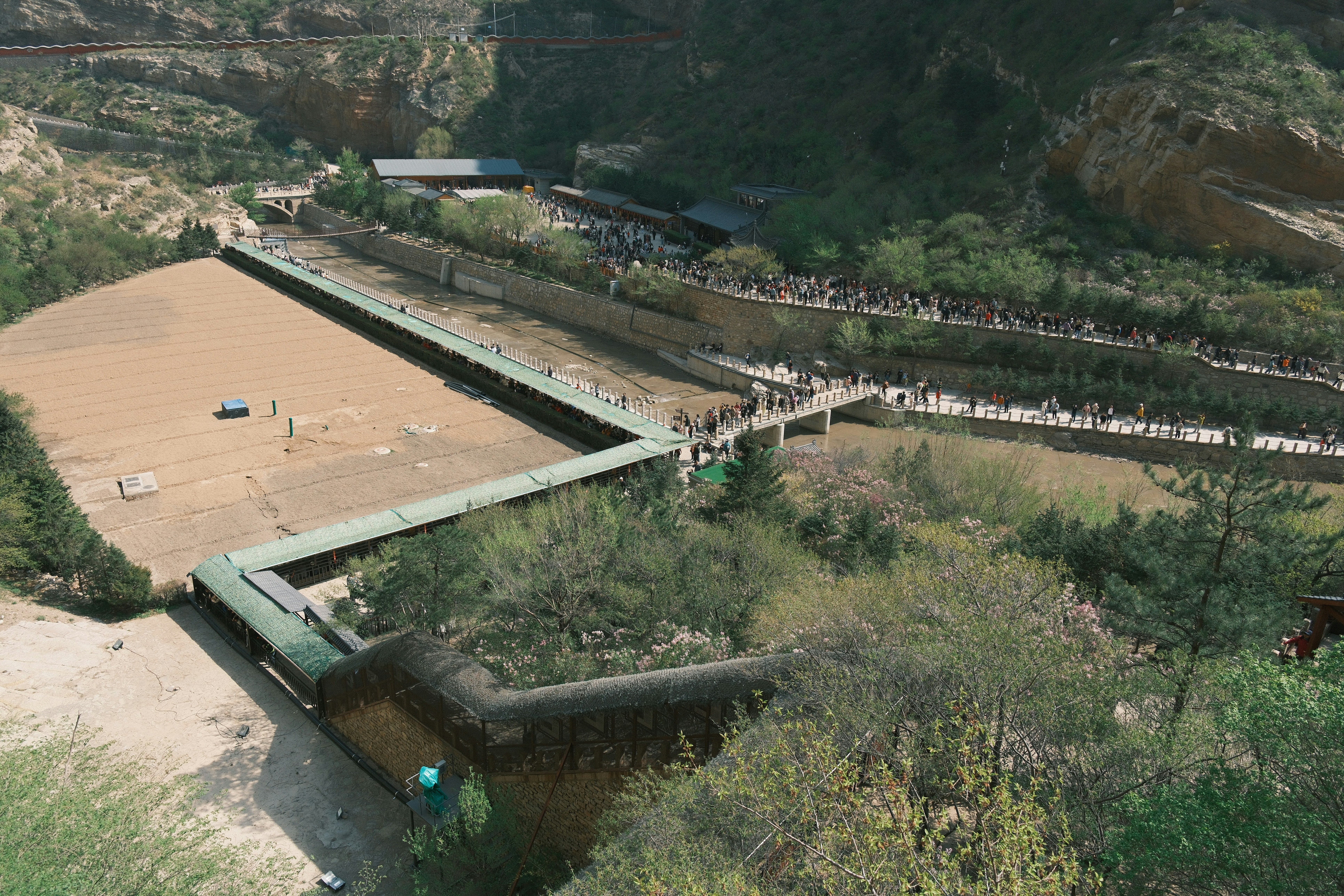 Crowds Along the Serpentine Fortress Walls from a Cliffside Aerial View