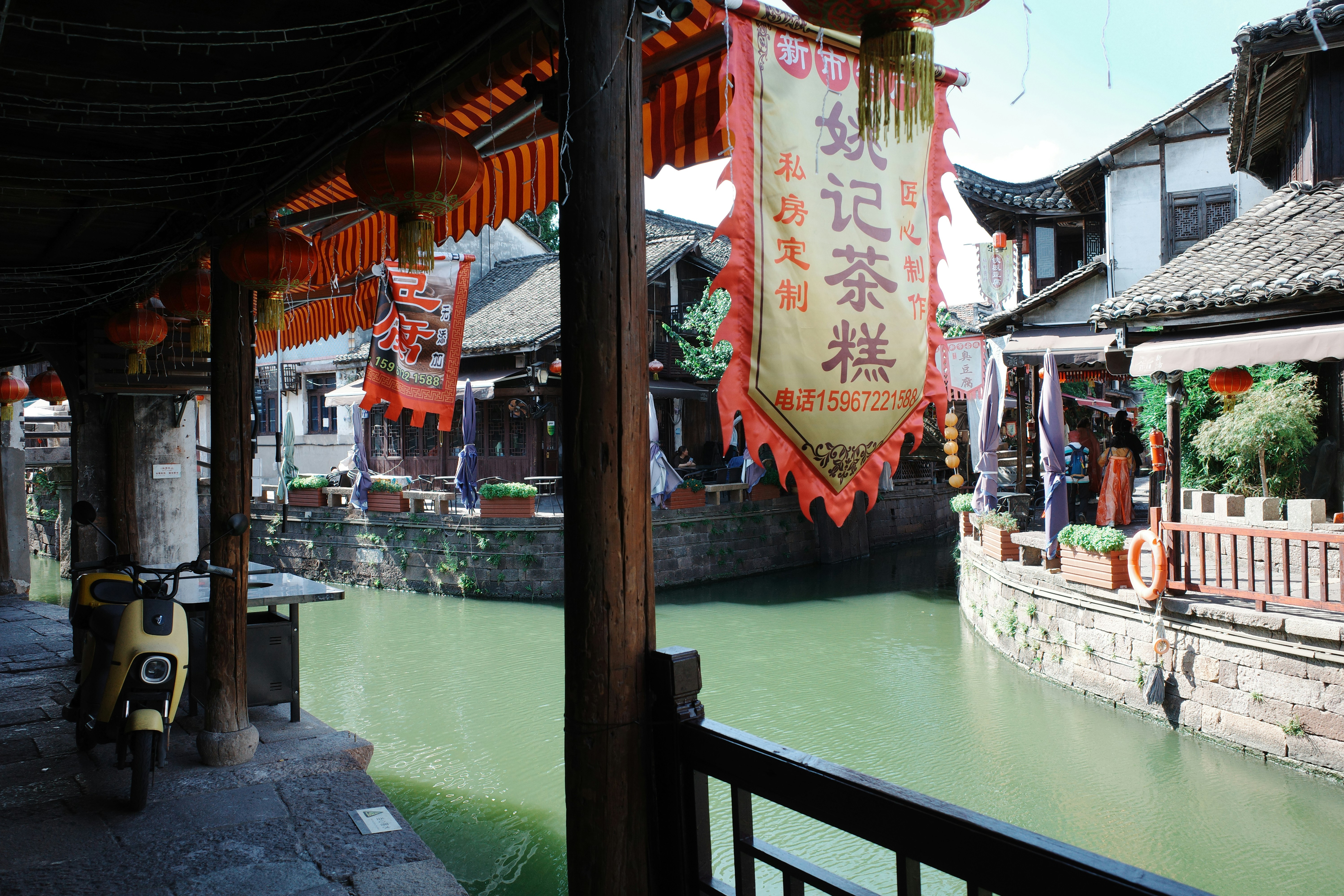 Amber Banner Over a Tranquil Canal: A Lantern-Lit Water Town Walkway