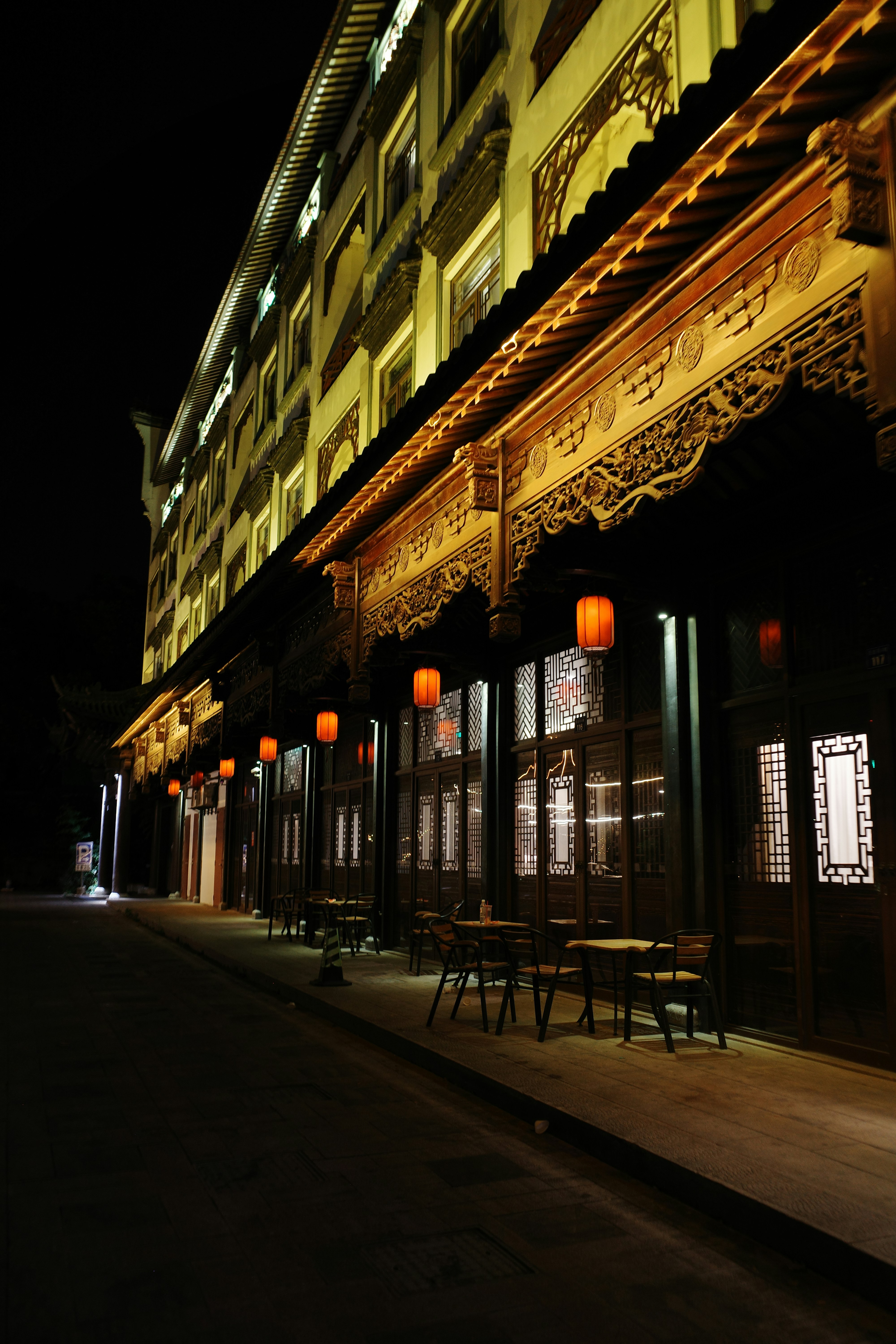 Ornate building facade with lanterns at night